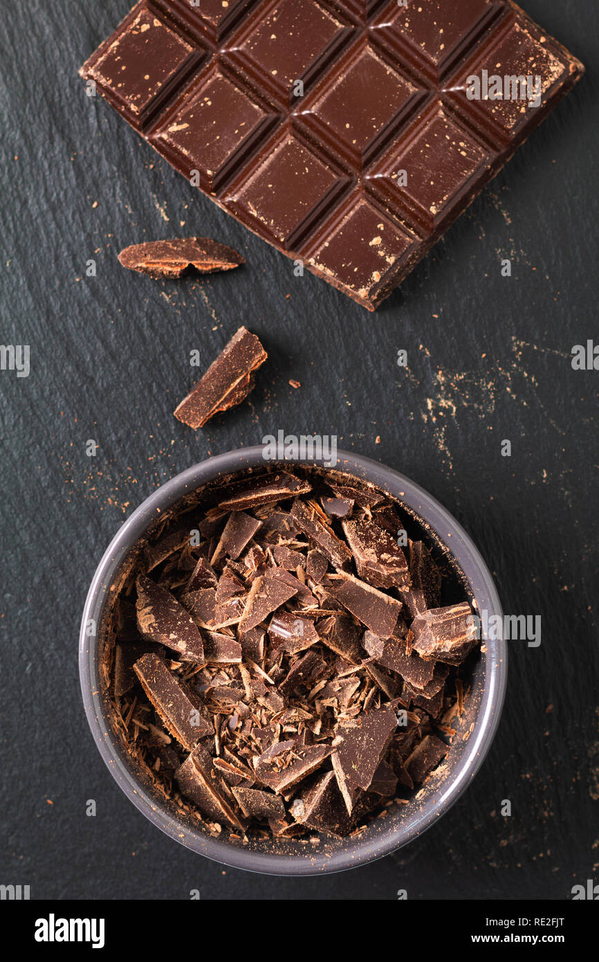 Bakery preparation Flat lay chopped milk chocolate in the gray ceramic ...