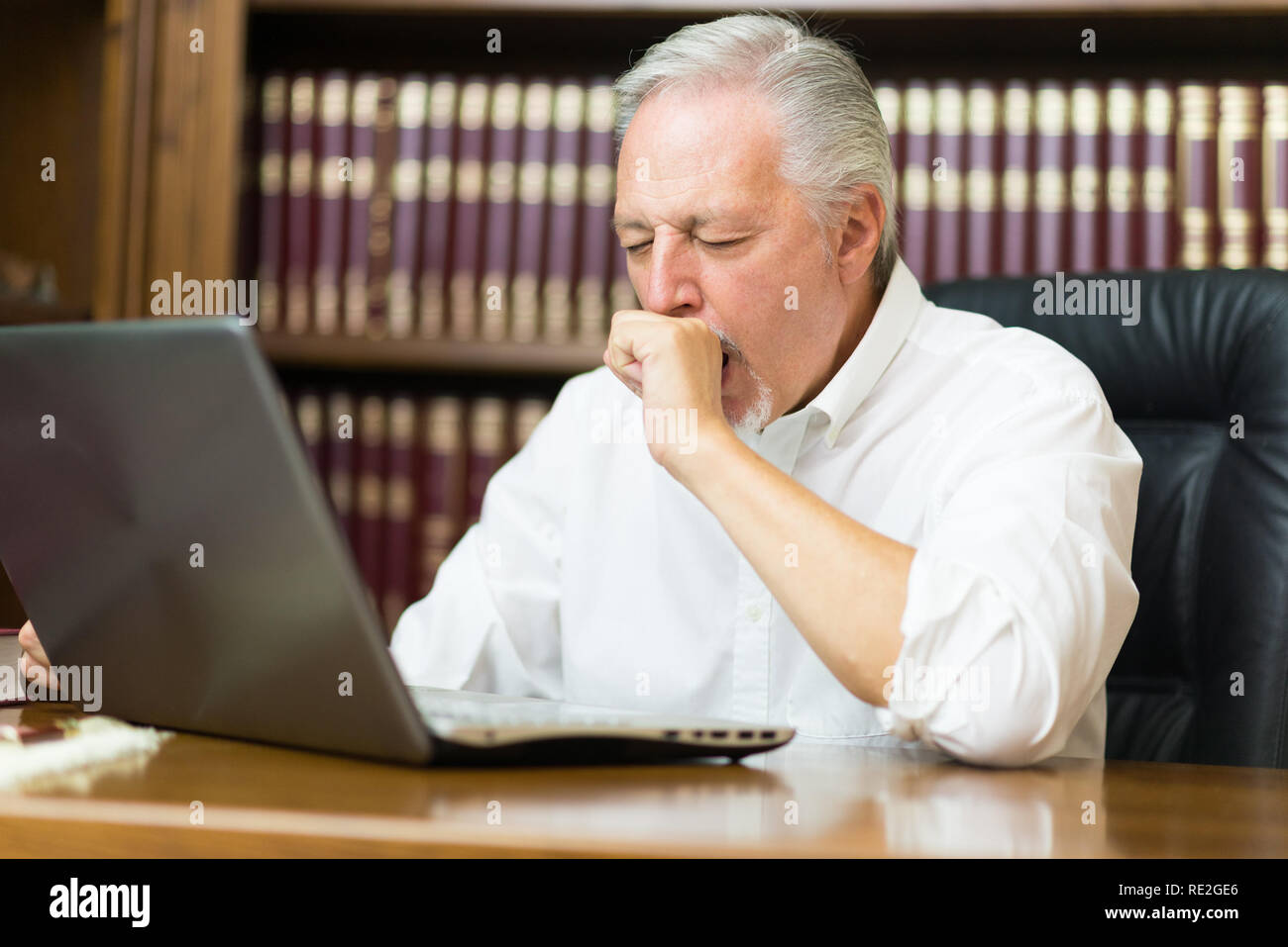 Tired business man yawning Stock Photo - Alamy Tired business man yawning Stock Photo - Alamy