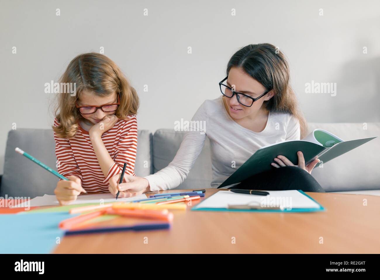 Young female teacher giving private lesson to child, little girl ...