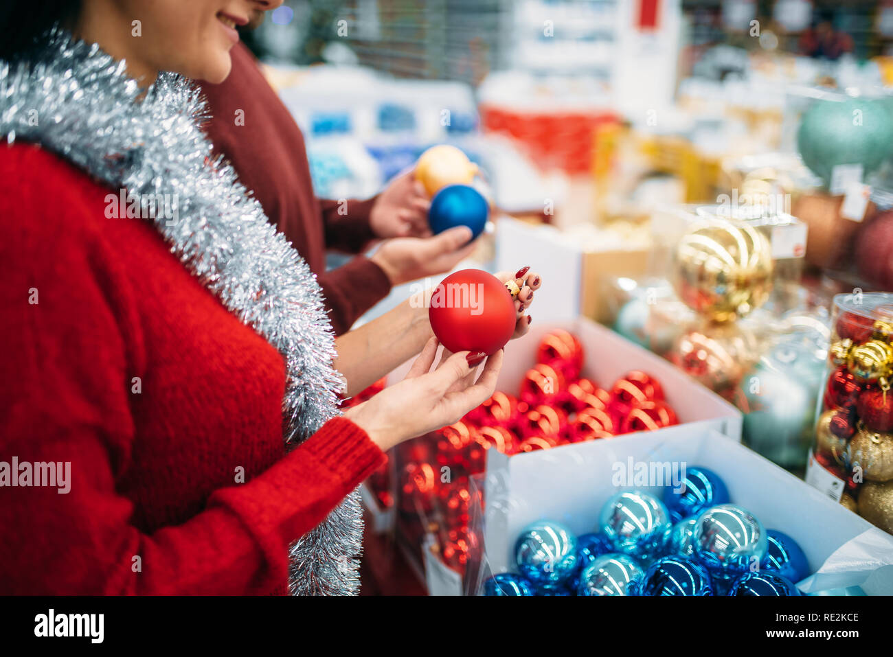 Female person buying christmas tree balls in supermarket, family ...