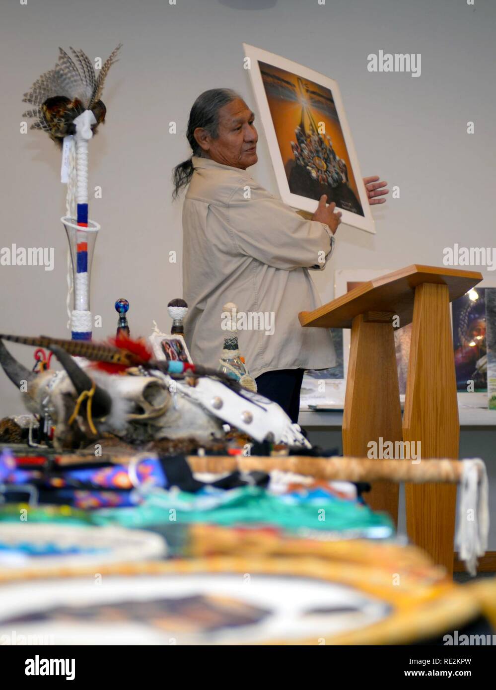 Daryl No Heart, a Lakota native storyteller, holds up a painting of a ...