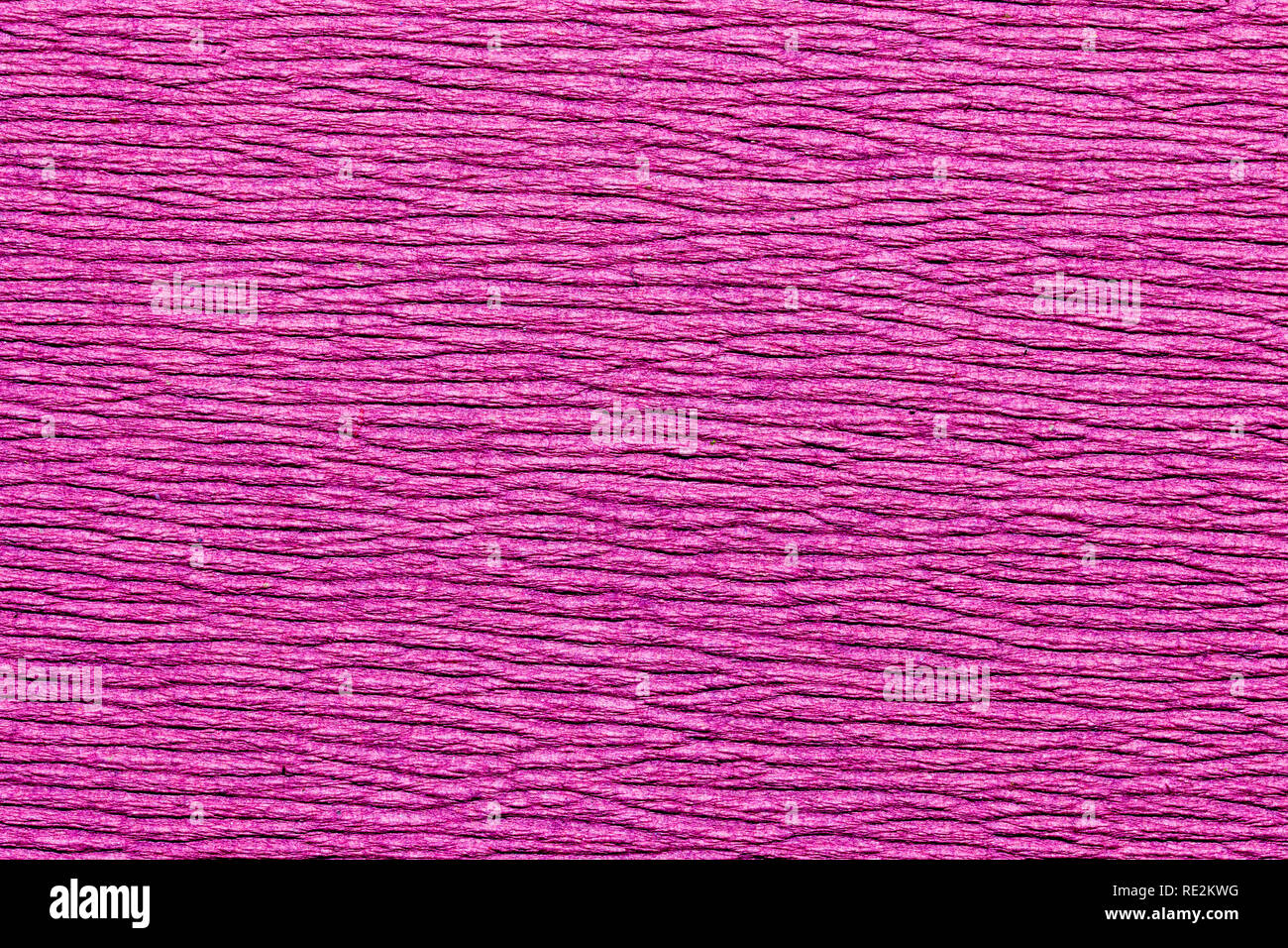 An abstract textured background created with colorful red crepe paper ...