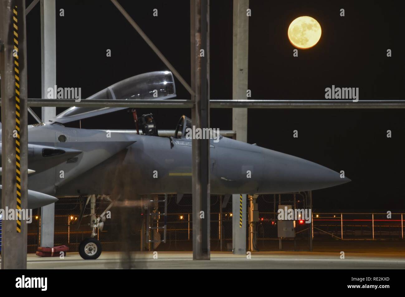The moon shines down on a U.S. Air Force F-15 Eagle from the 144th ...