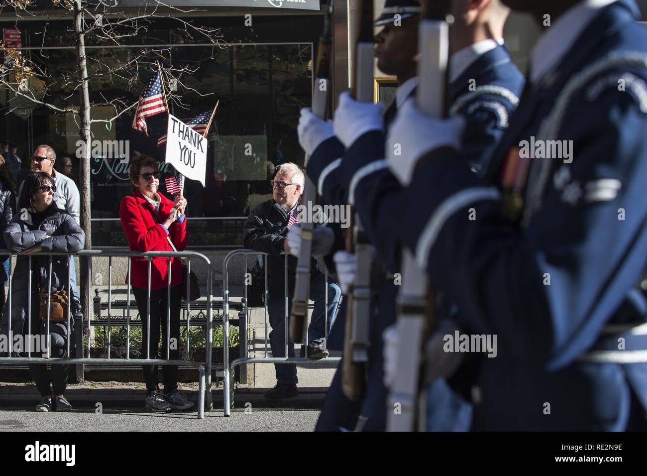 A parade viewer holds a sign of thanks while the U.S. Air Force Honor ...