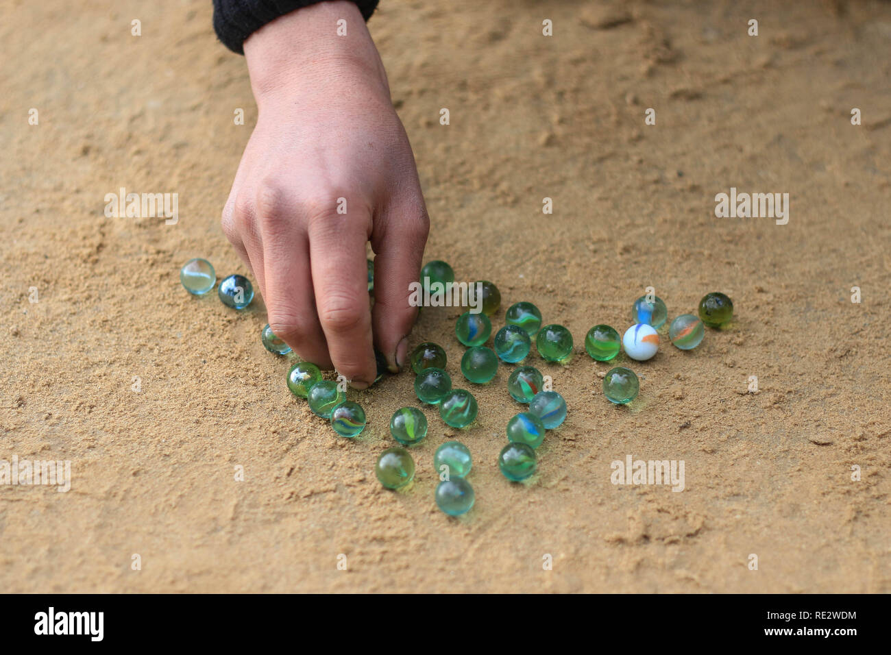 A children seen placing his balls while playing the 'marbles', one of ...