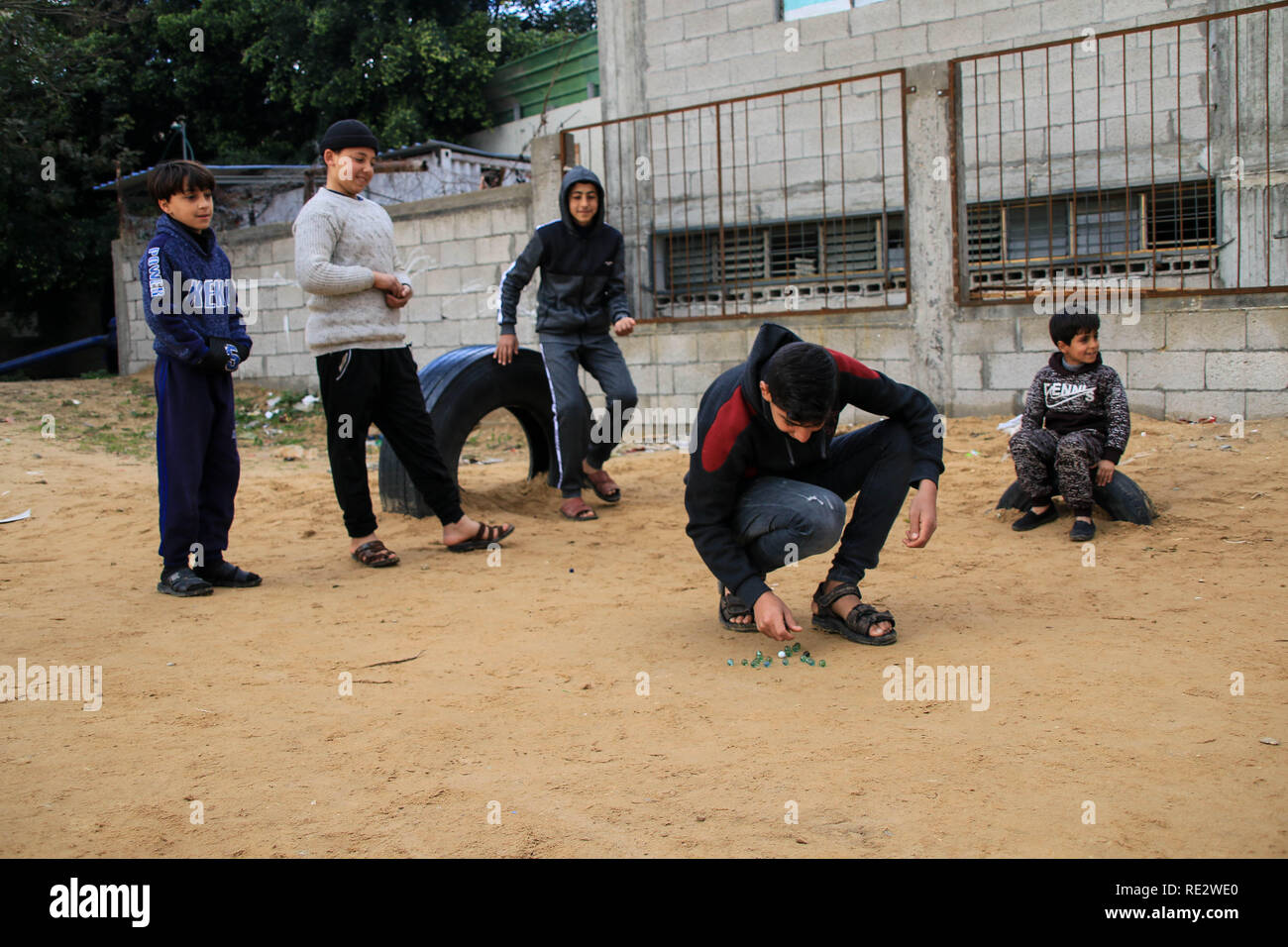 Children play the 'marbles', one of the most popular Palestinian game ...