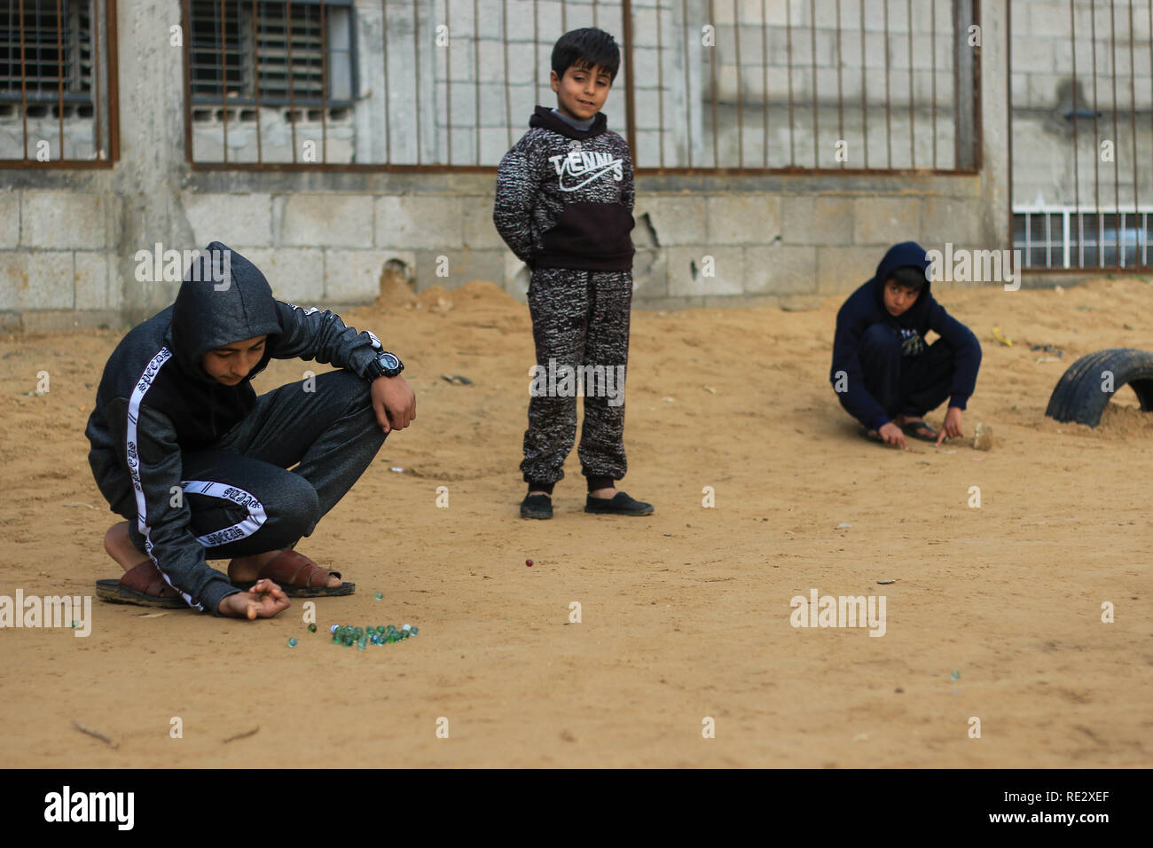 Gaza, Palestine. 18th Jan, 2019. Children play the 'marbles', one of ...