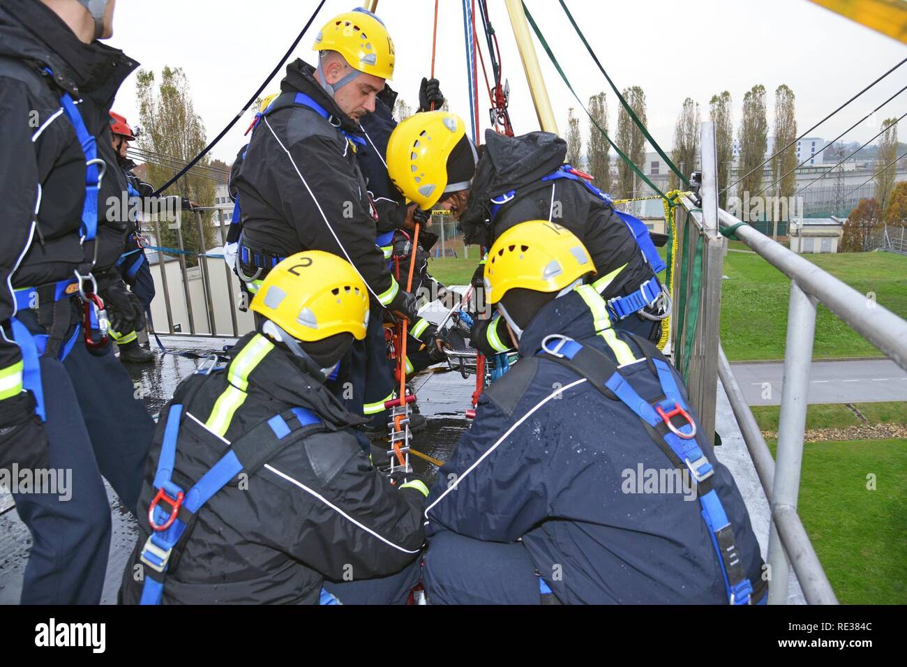 Firefighters assigned to the U.S. Army Garrison Italy, use rope work ...