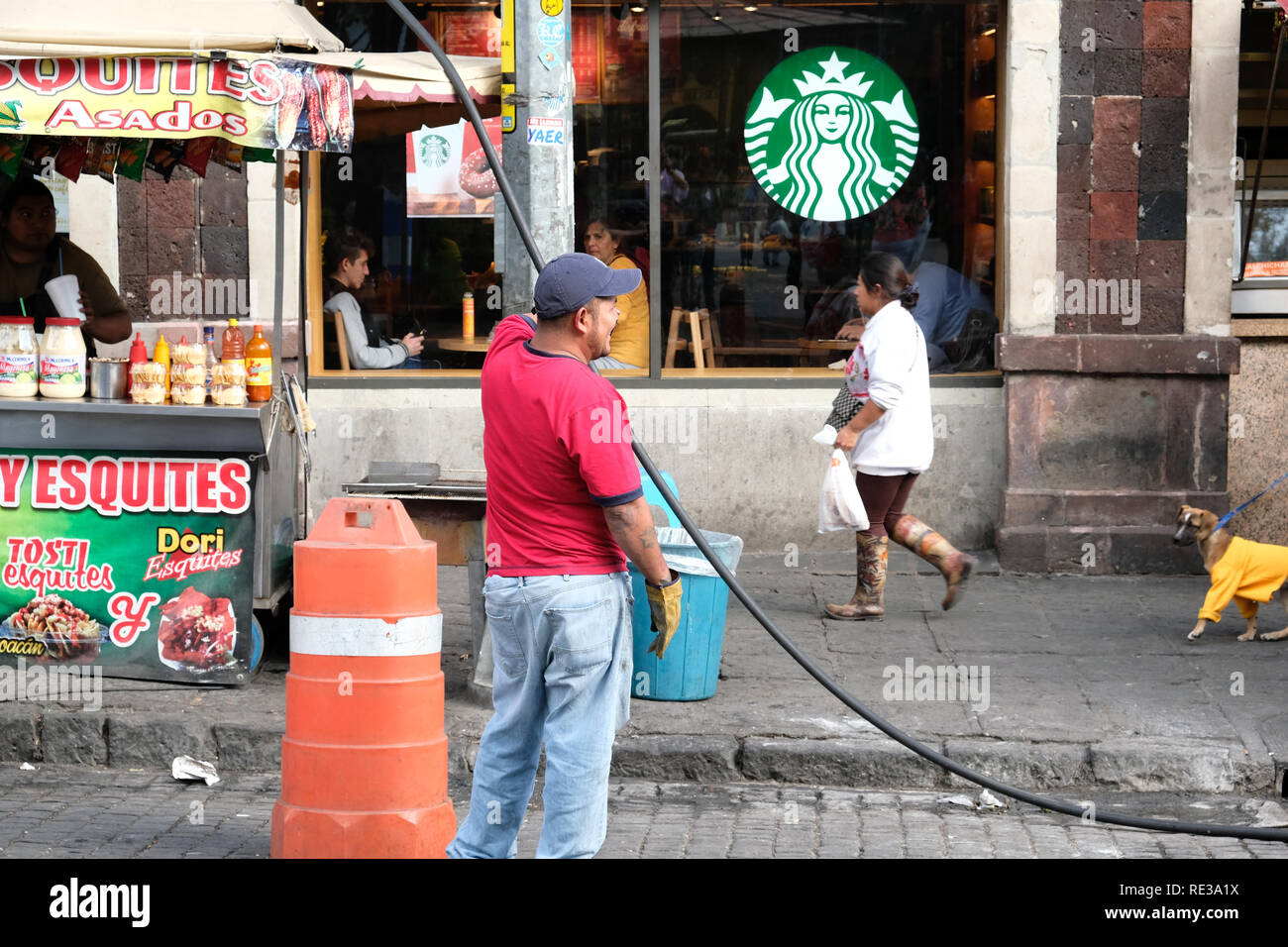 A Mexican man working in front of a Starbucks coffee store in Cholula ...