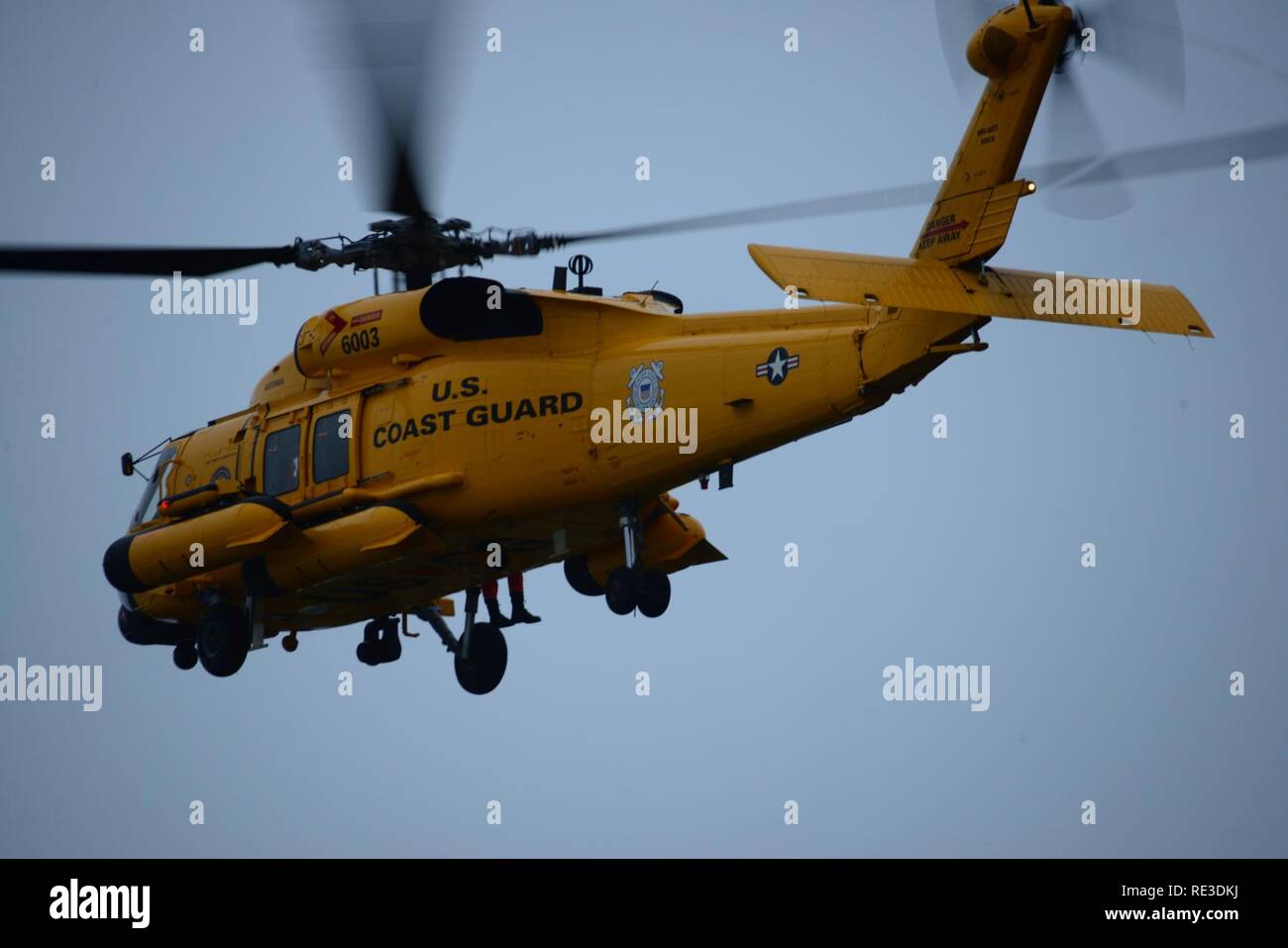 An aviation survival technician prepares to deploy from an MH-60 ...
