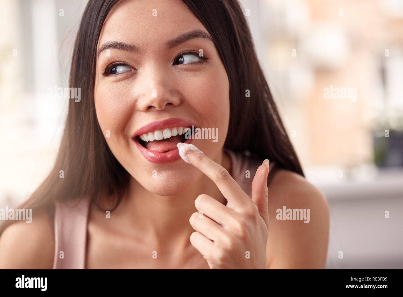 Young girl at kitchen healthy lifestyle standing tasting shake with ...