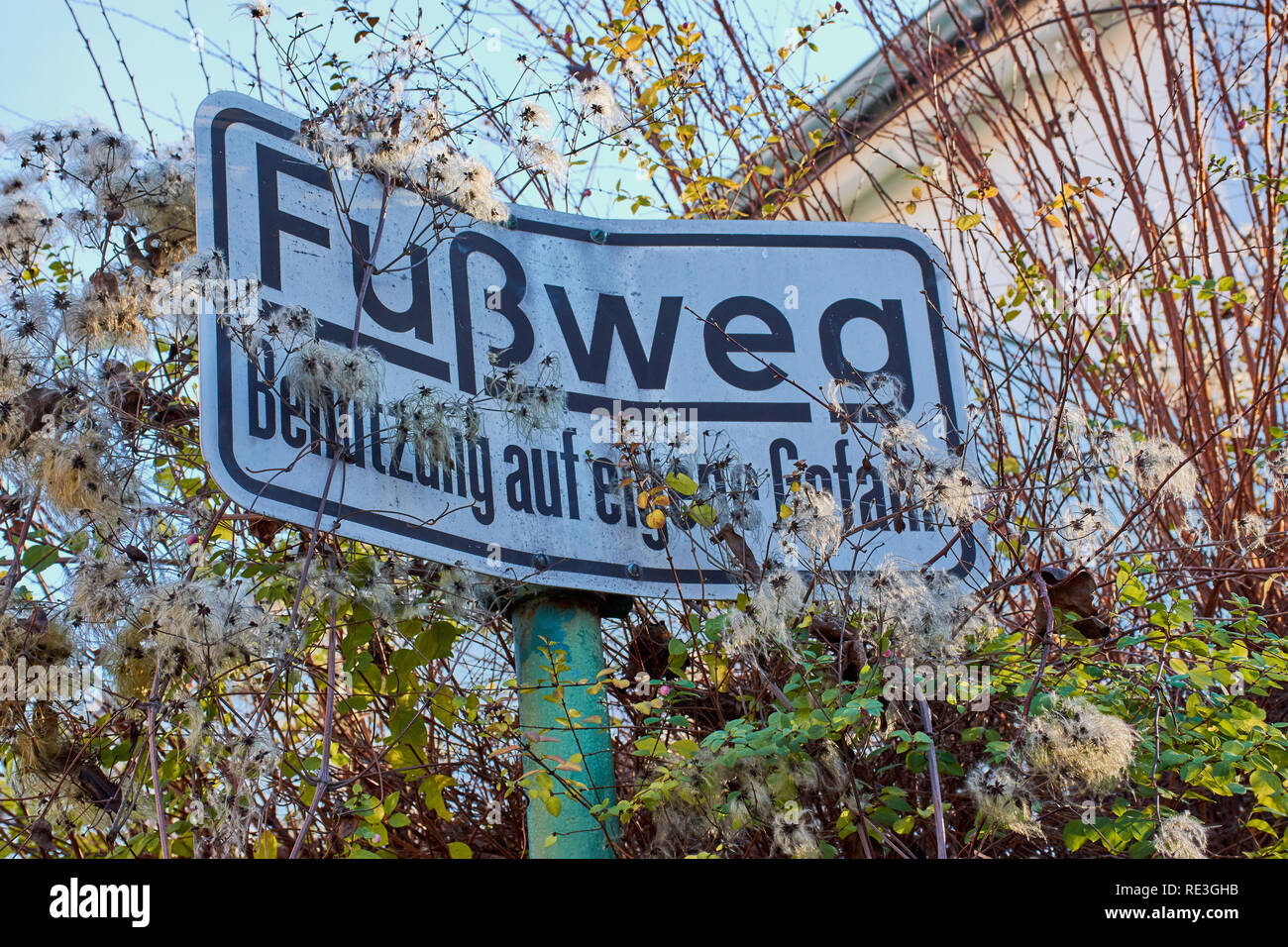 sign with the German words for: footpath - use at your own risk Stock ...