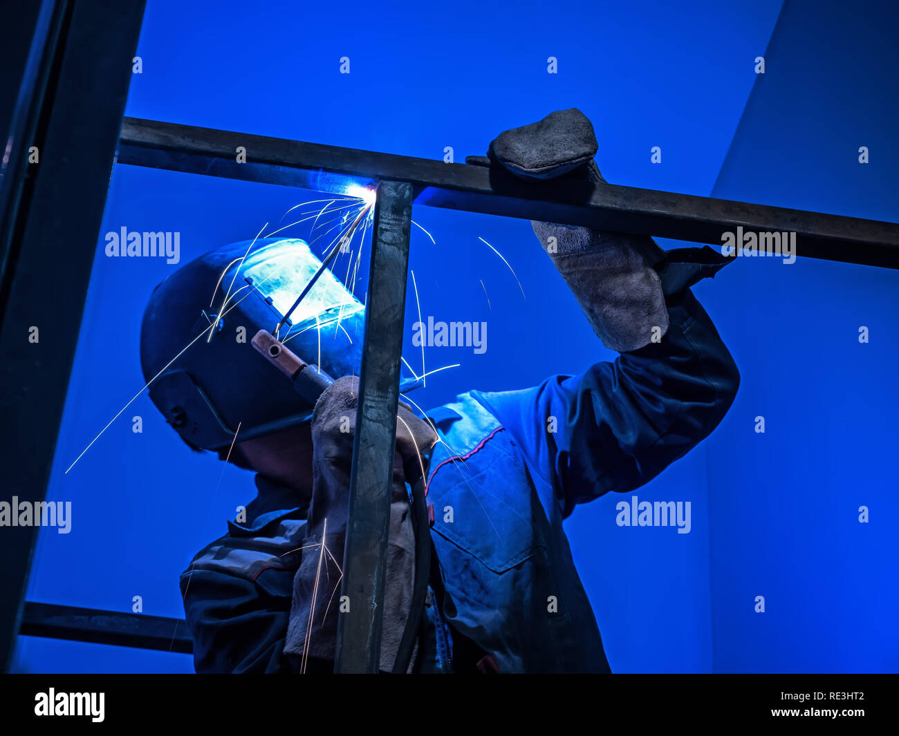 Welder Worker Performs Jump Welding. Worker Welder Performs Arc-Welding ...