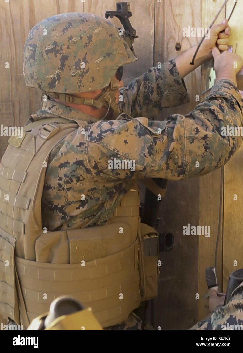 U.S. Marine Lance Cpl. Ryan Malley sets up a hinge charge in ...