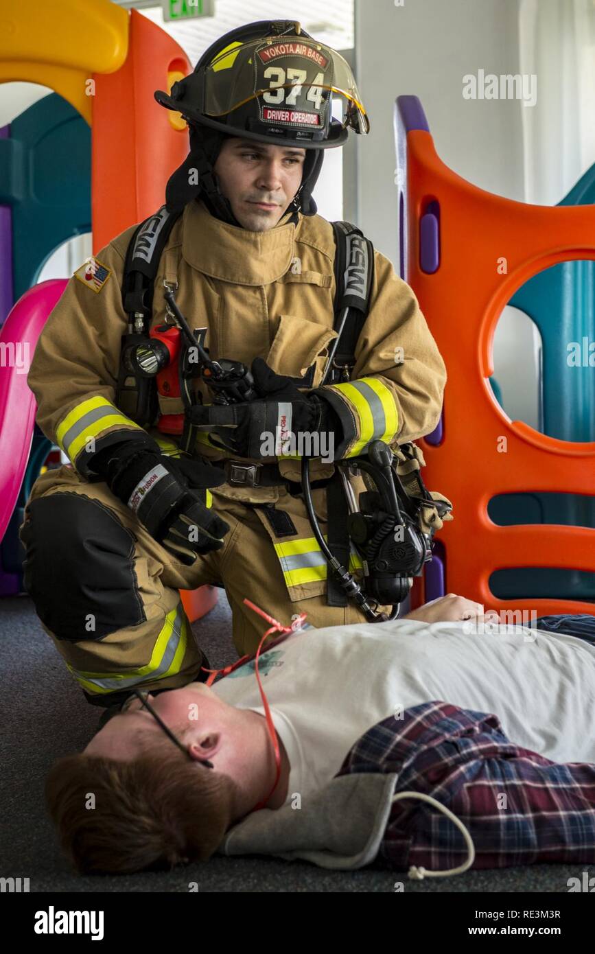 A Firefighter from the 374th Civil Engineer Squadron radios in the ...