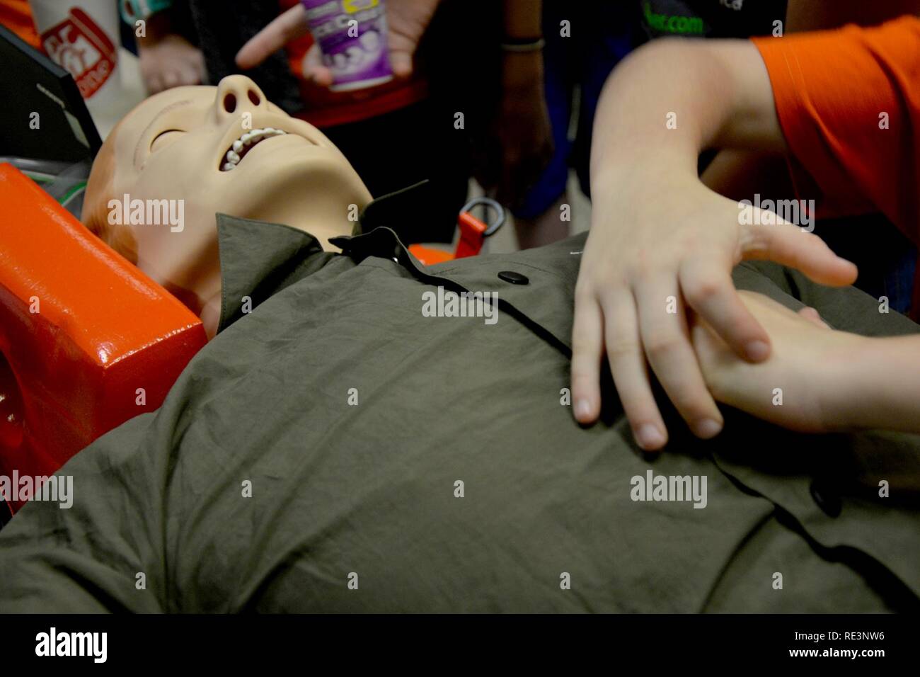 A child learns to performs chest compressions on a SimMan during the ...