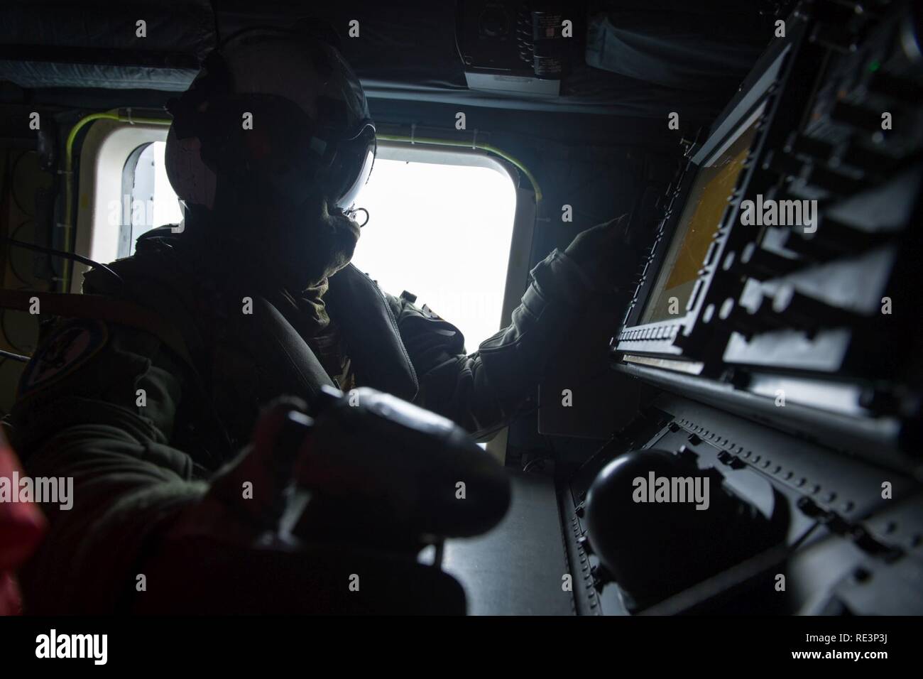 Seaman Jordan Russell surveys the coastline from a MH-60R Sea Hawk from ...