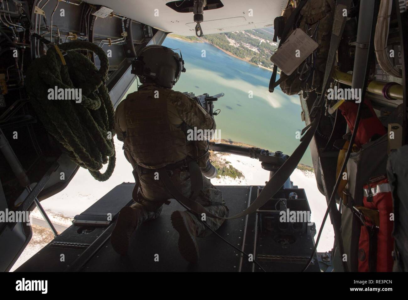 A gunner stands ready from the back of a V-22 Osprey aircraft during a ...