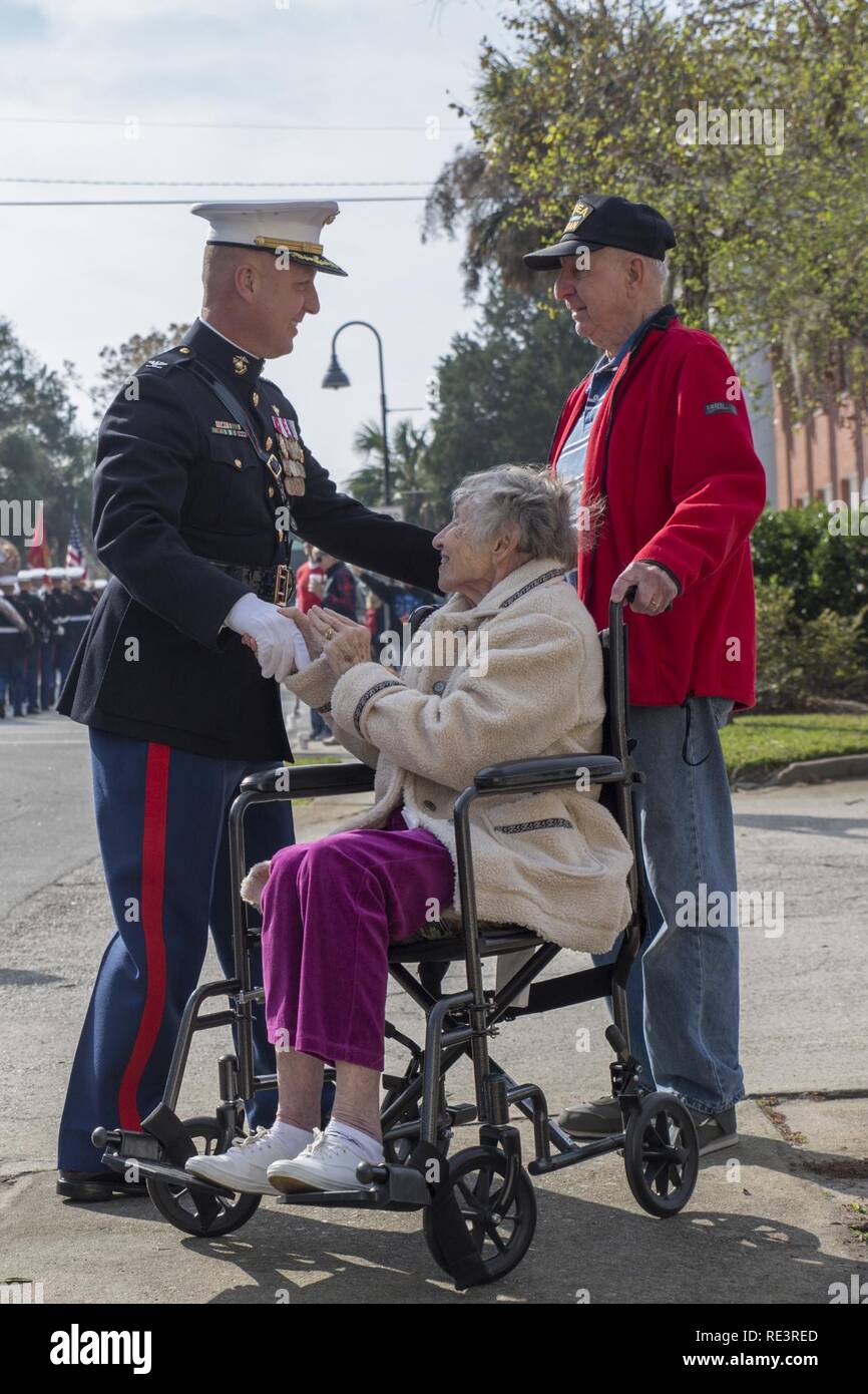 Col. Peter Buck greets a veteran and his family along the parade route ...