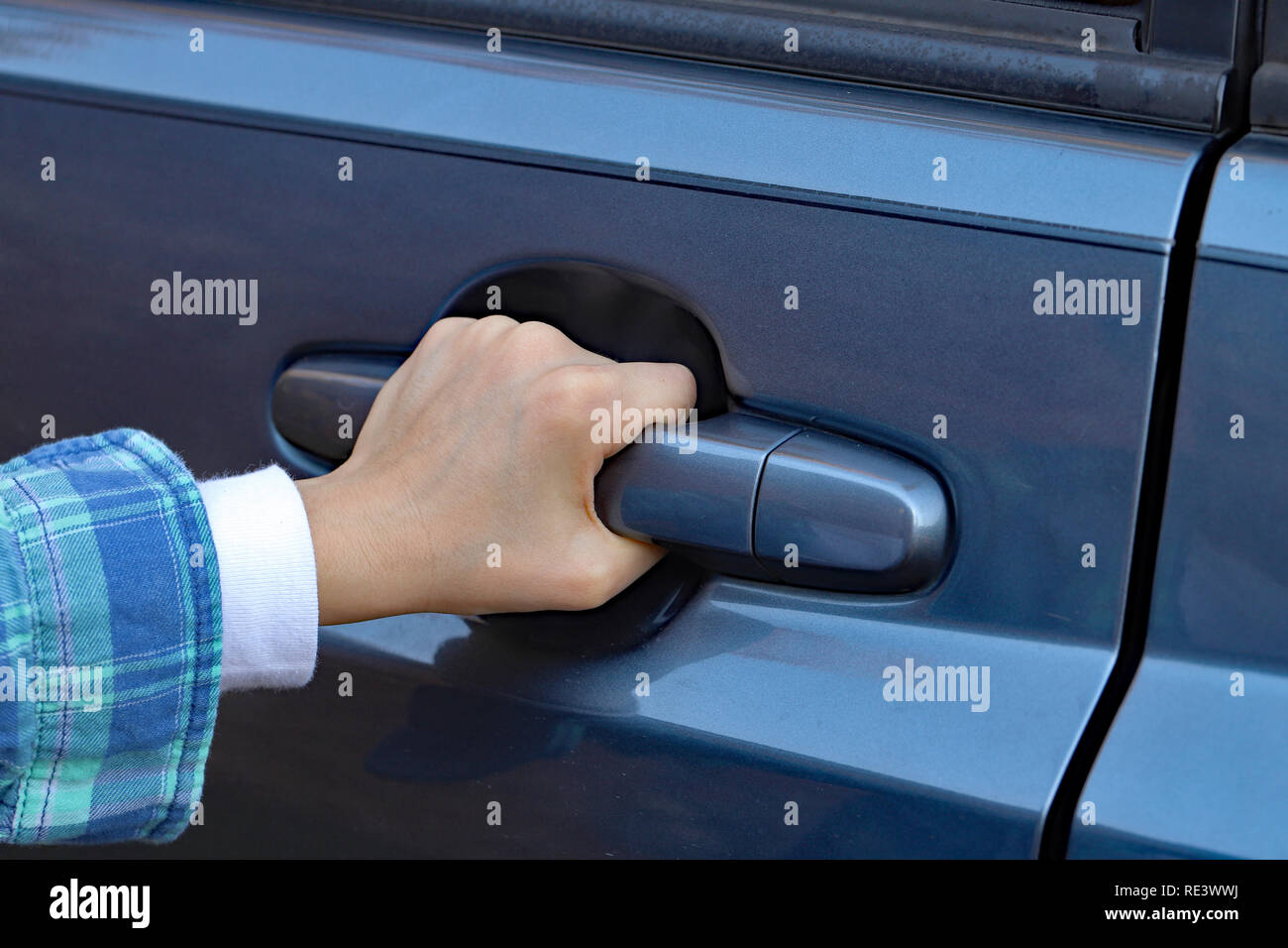 Child's hand gripping vehicle car door handle Stock Photo - Alamy