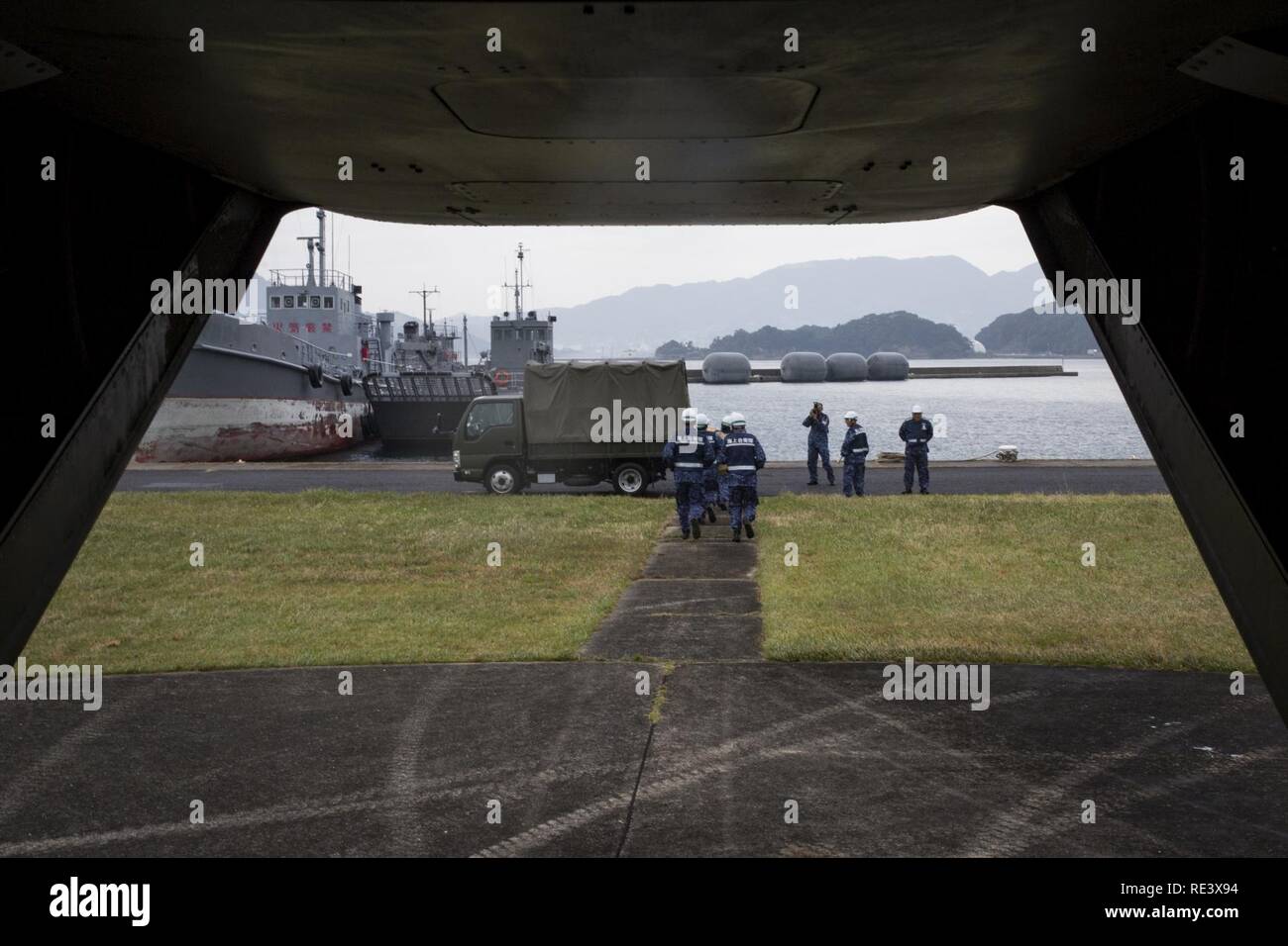 Japan Maritime Self-Defense Force (JMSDF) members carry simulated ...
