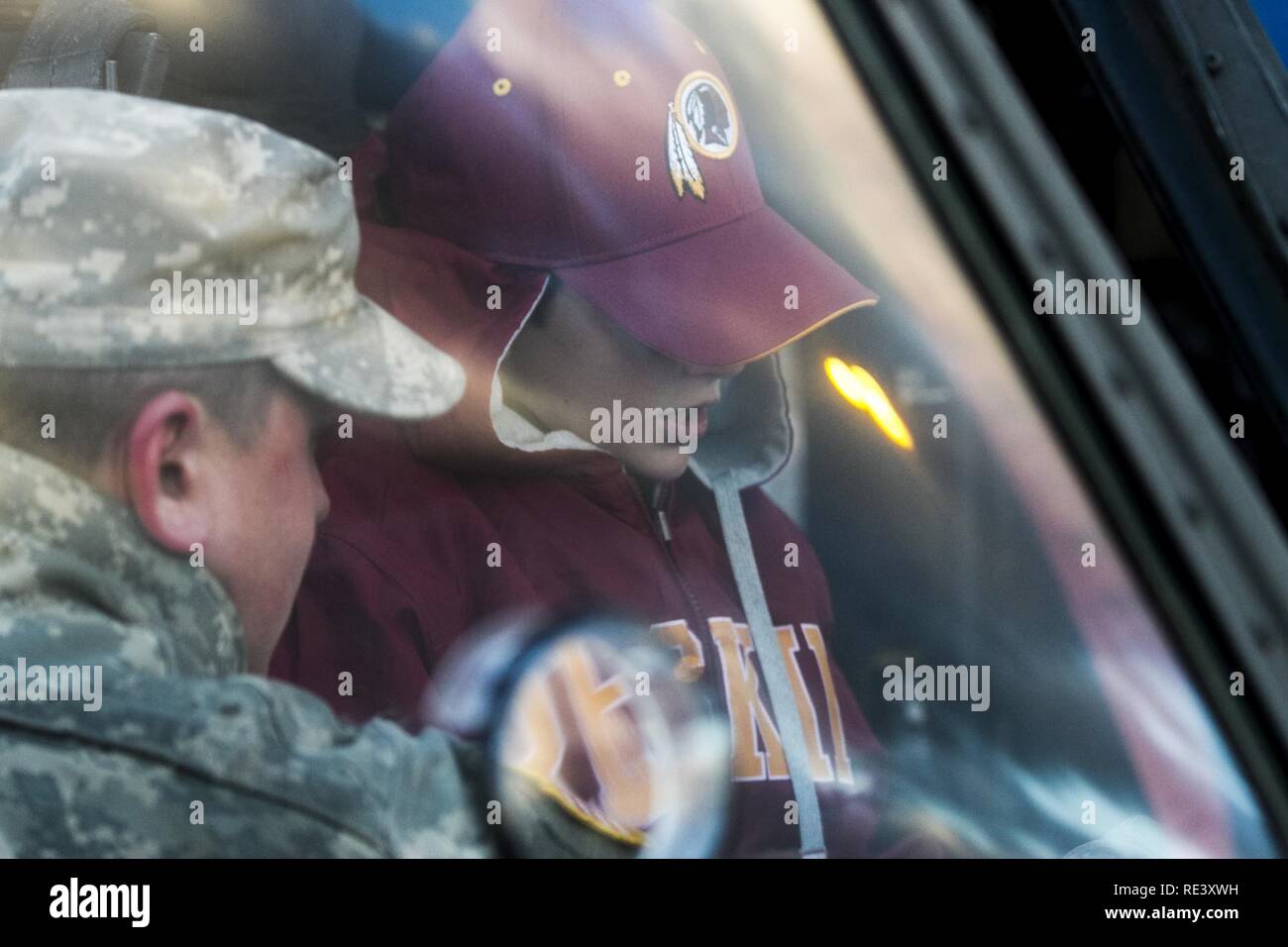 A young boy sits inside a U.S. Army Black Hawk from Bravo Company, 12th ...