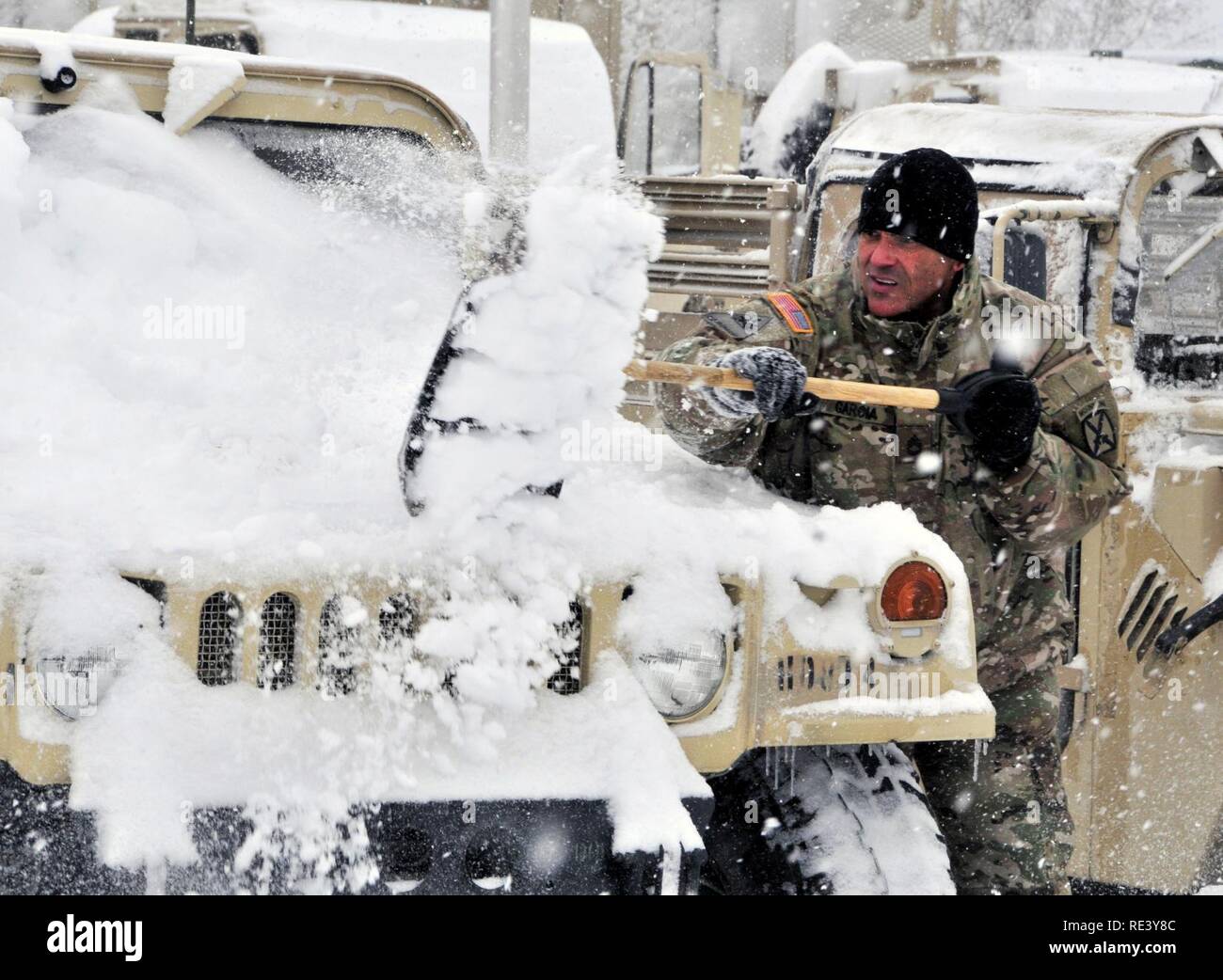 A 10th Mountain Division Sustainment Brigade Soldier shovels snow off a ...
