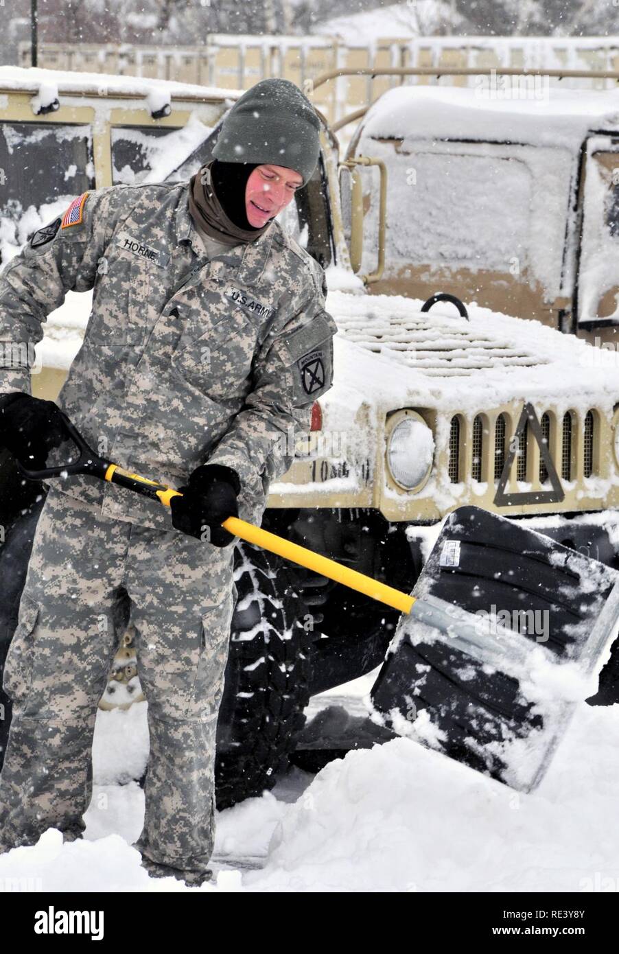 Sgt. Horne of the 10th Mountain Division Sustainment Brigade shovels ...