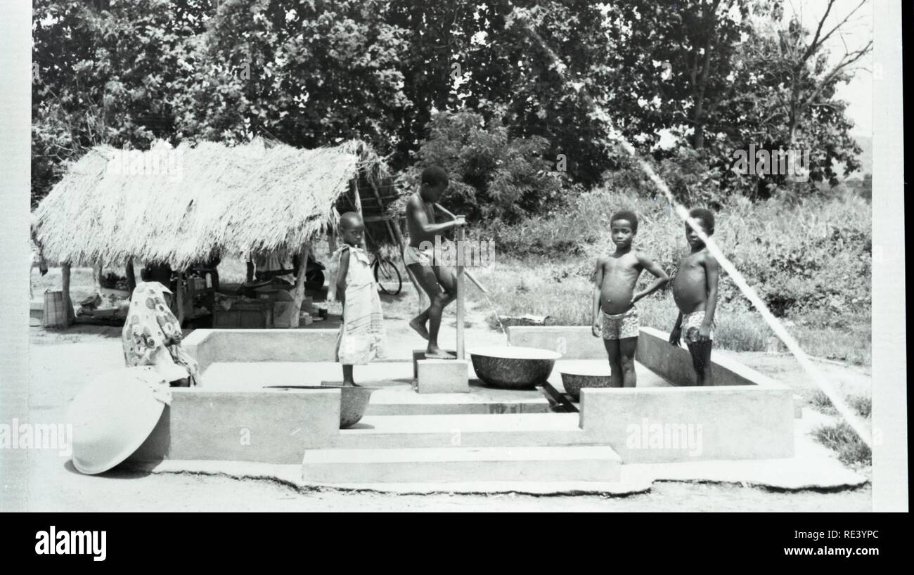 CHILDREN RETRIEVING WATER FROM A WELL Stock Photo - Alamy