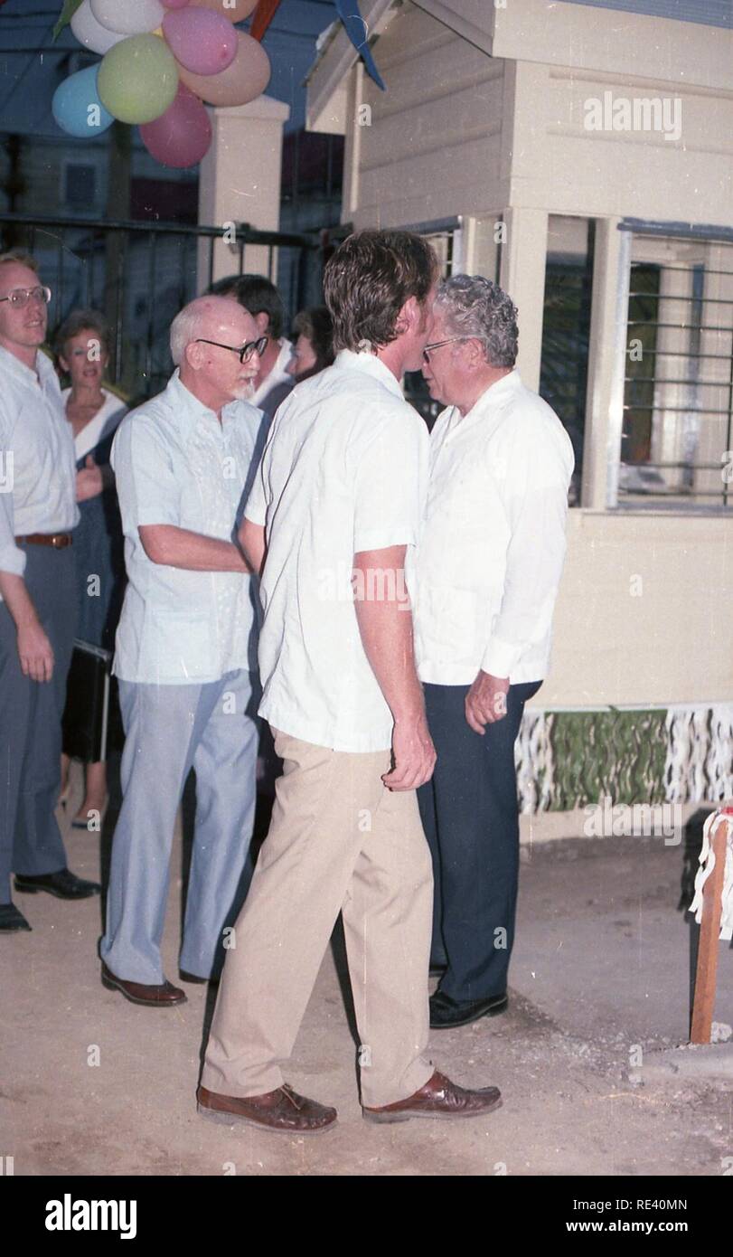 MEN AND WOMEN SHAKING HANDS WITH EACH OTHER IN A RECEIVING LINE. THE ...