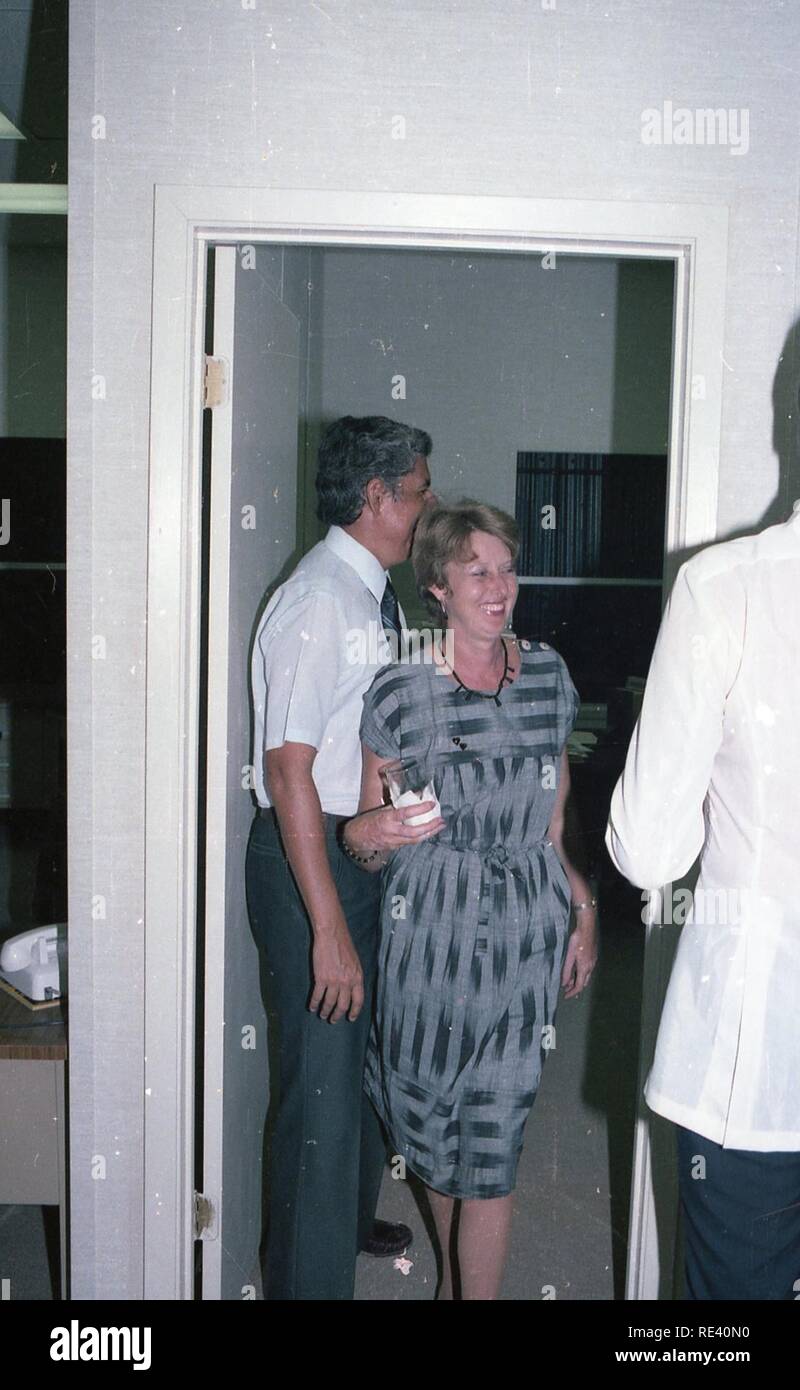 MAN STANDING AT THE THRESHOLD OF DOOR INSIDE A BUILDING, WHILE WOMAN ...