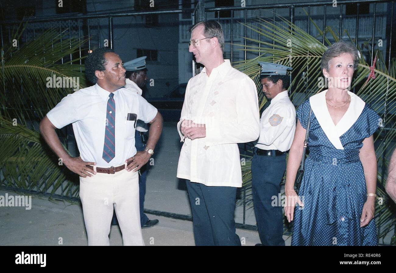 TWO MEN TALKING WITH ONE ANOTHER. PEOPLE IN BACK GROUND. TWO MEN IN ...