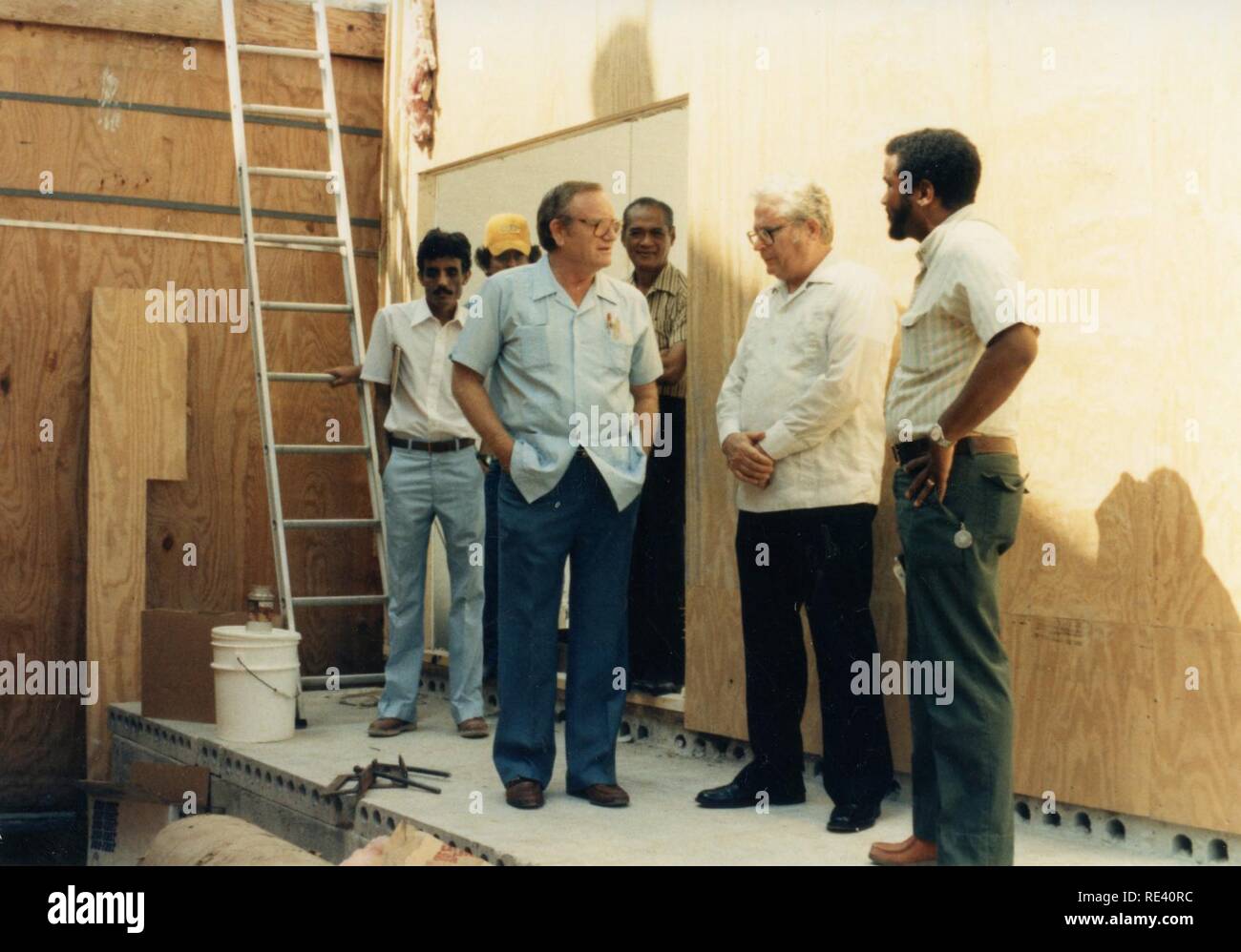 Group of men observing construction Stock Photo - Alamy