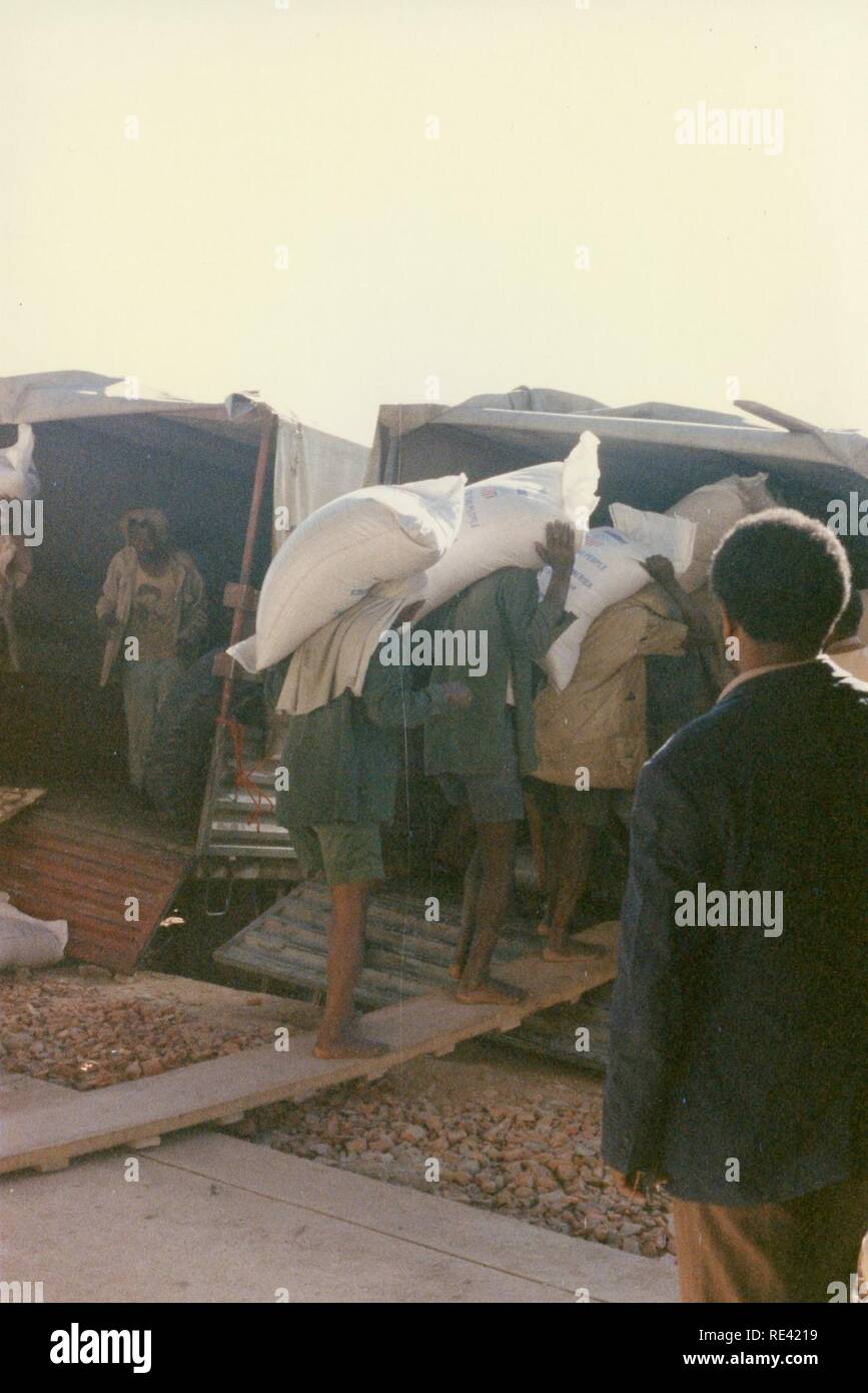 MEN LOADING BAGS IN TO A TRUCK Stock Photo - Alamy