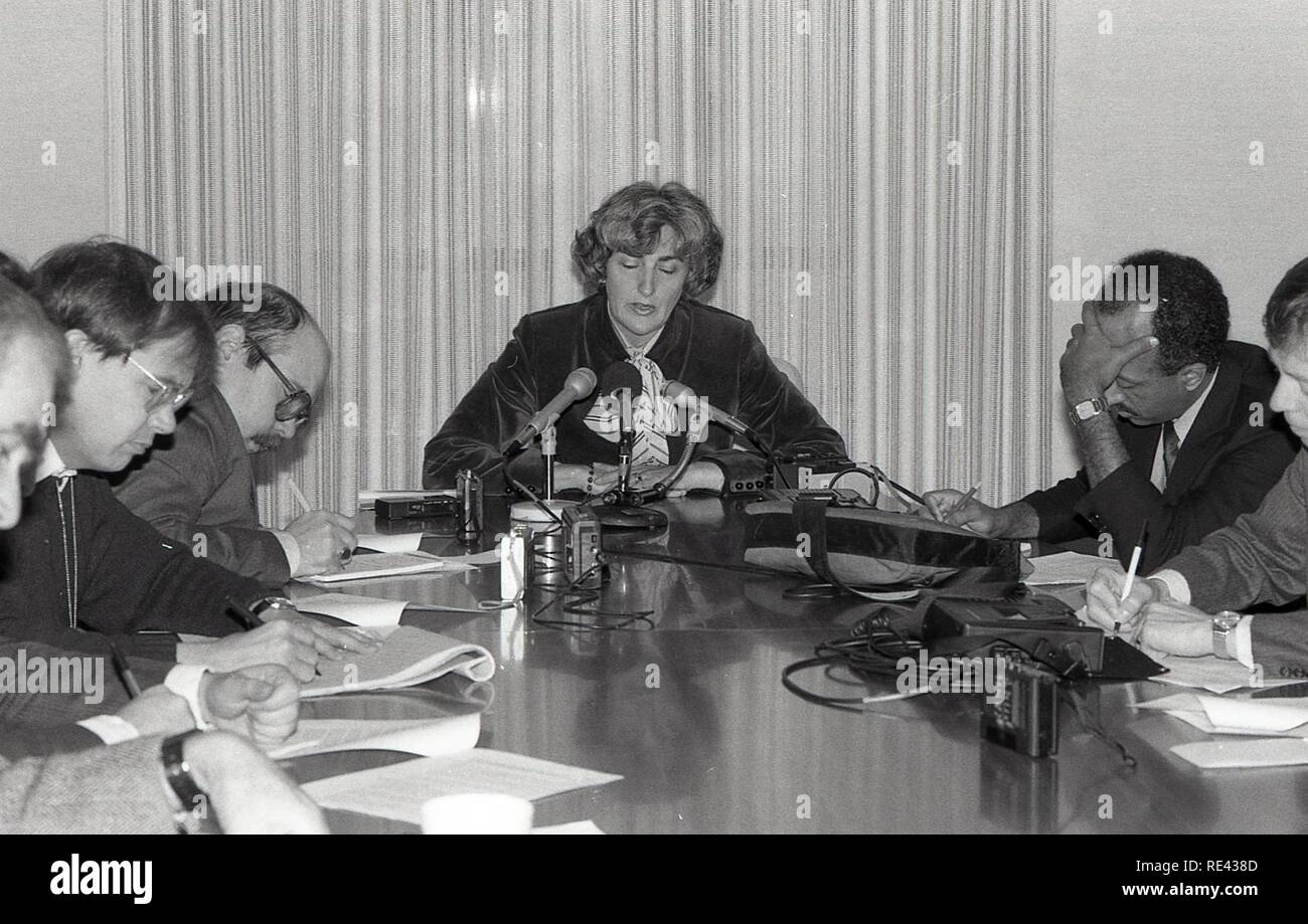 SITTING AT CONFERENCE TABLE WRITING Stock Photo - Alamy