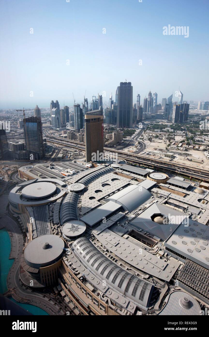 View of the Dubai Mall in front of the skyline of the buildings on ...