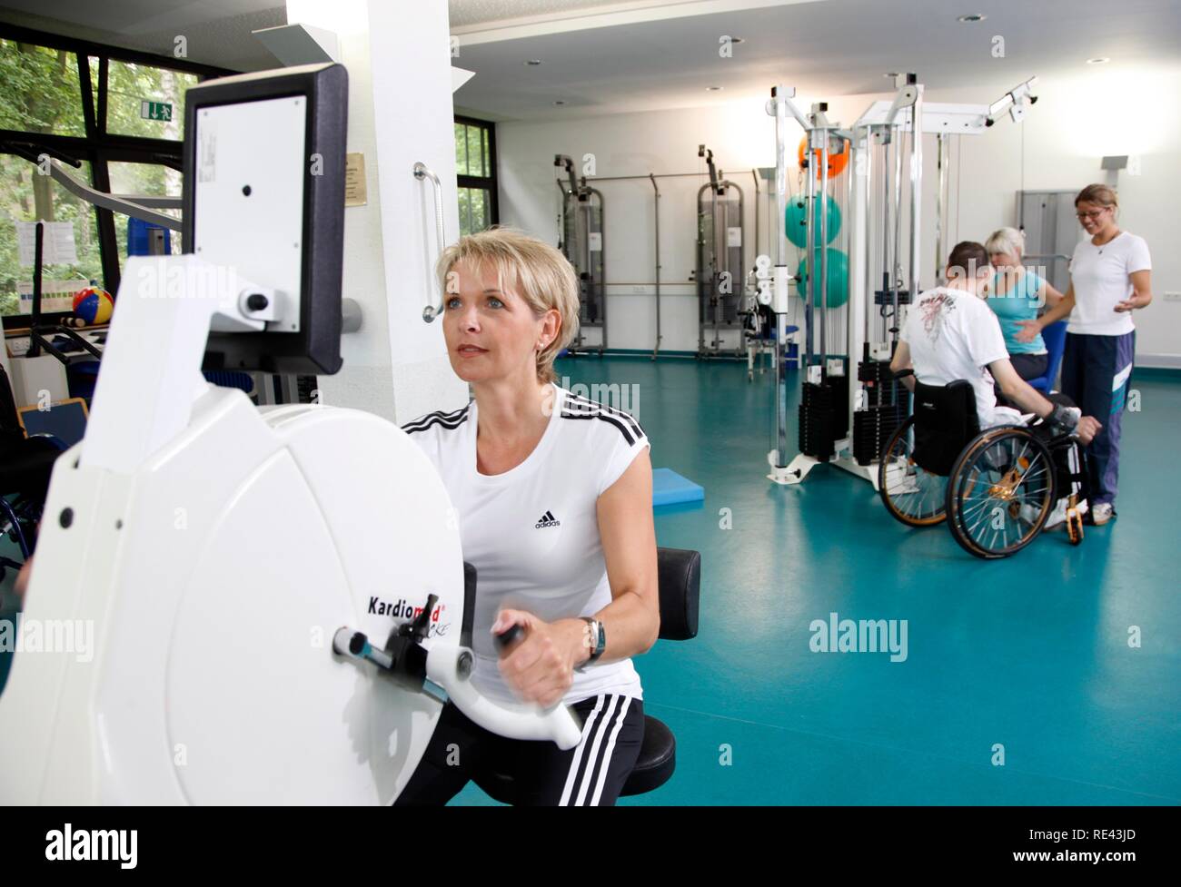 Patients during muscle strength training on various machines in a gym ...