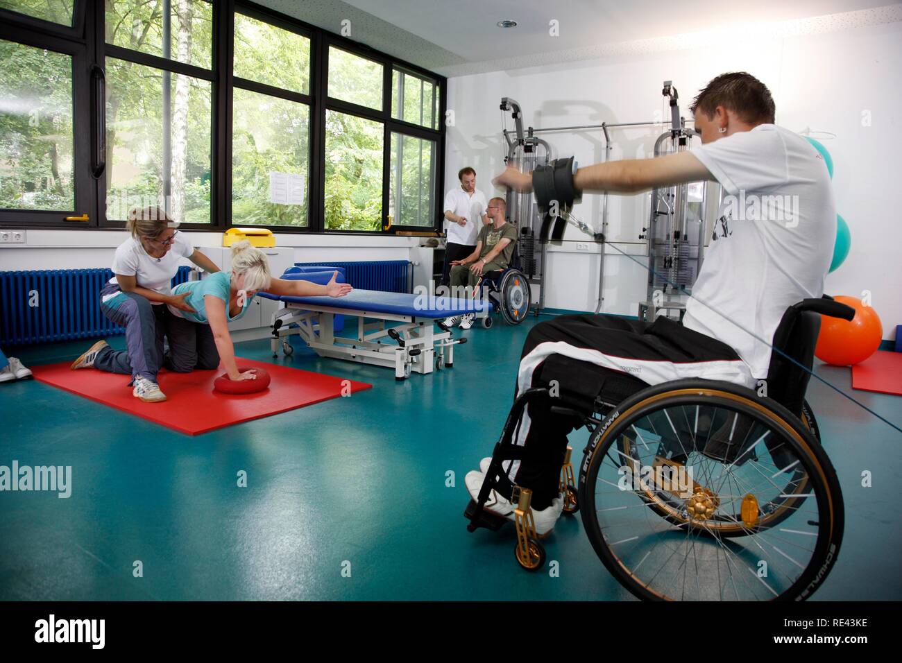 Patients during muscle strength training in a gym, gymnastic exercises ...