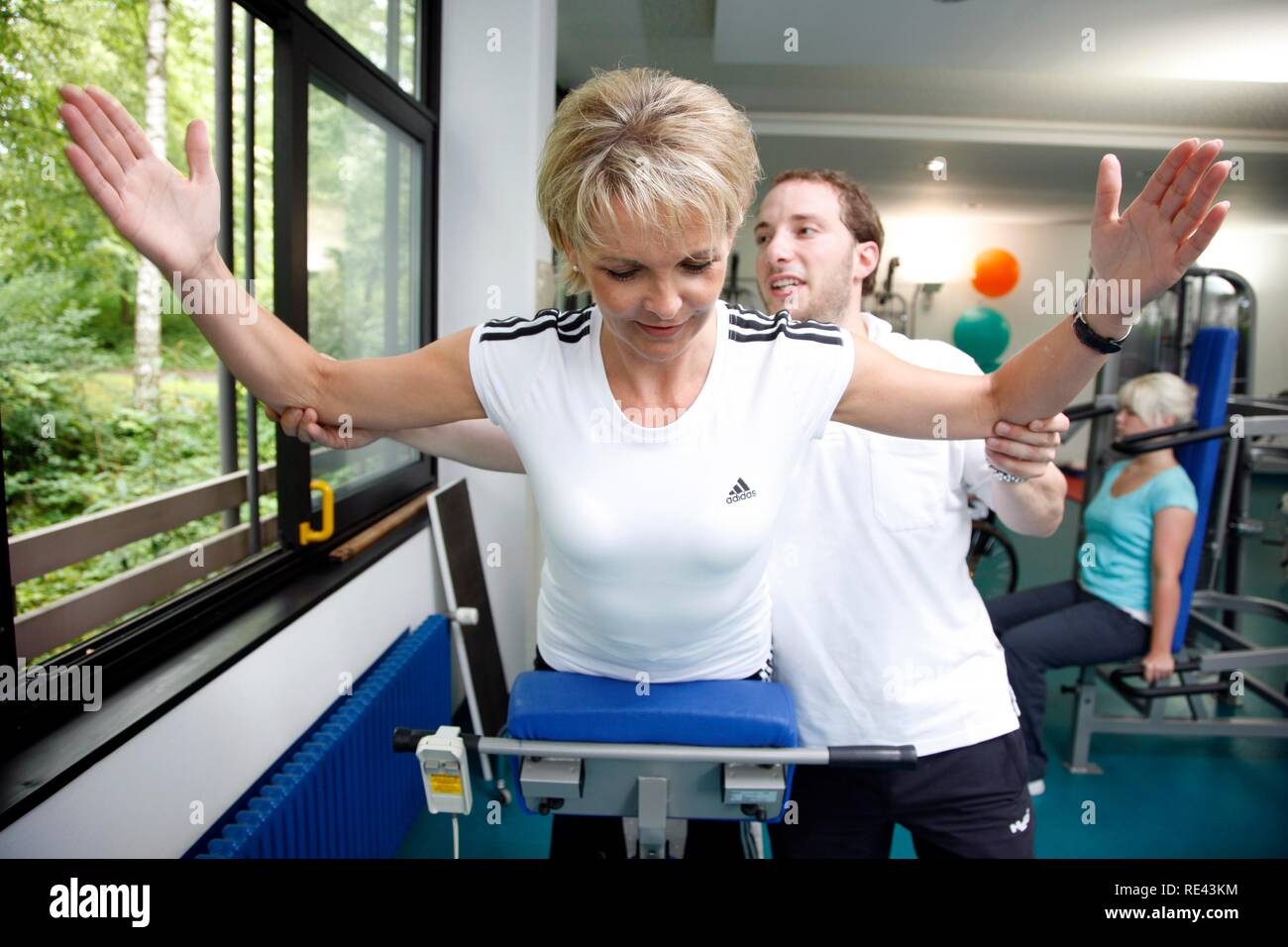 Patients during muscle strength training on various machines in the ...