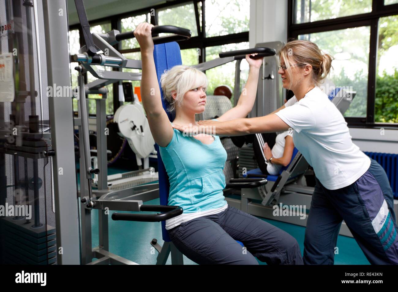Patients during muscle strength training on various machines in the ...