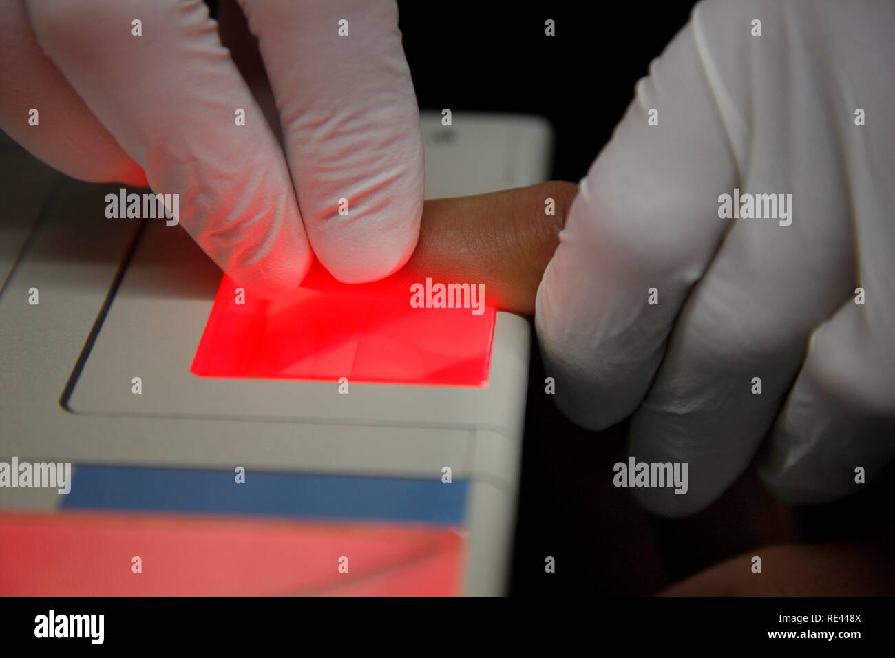 Fingerprints and handprints being recorded by digital scanner, physical ...