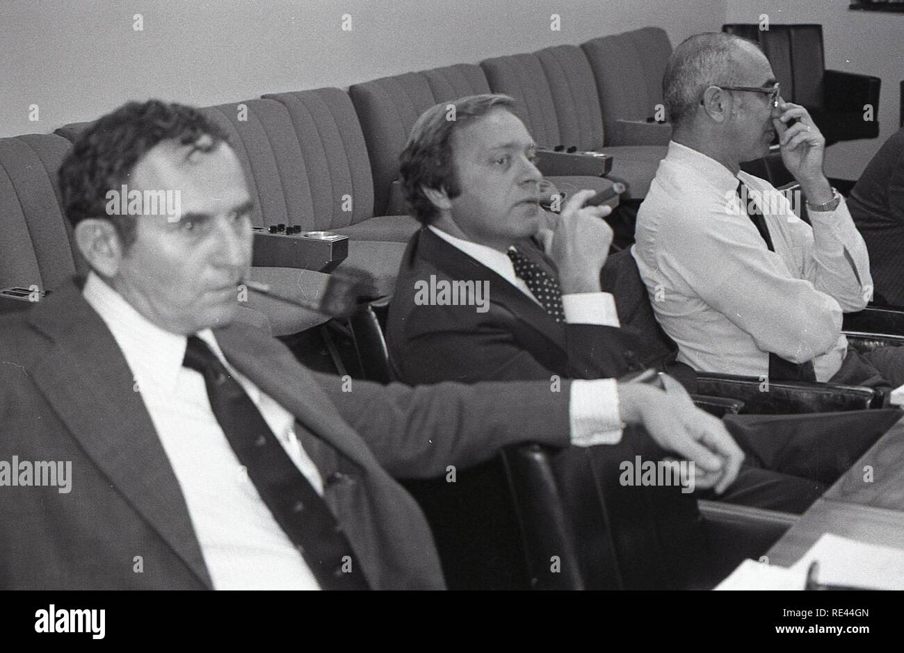 MEN SITTING GATHERED AROUND A TABLE, HAVING A MEETING. 4-12-78 LA ...