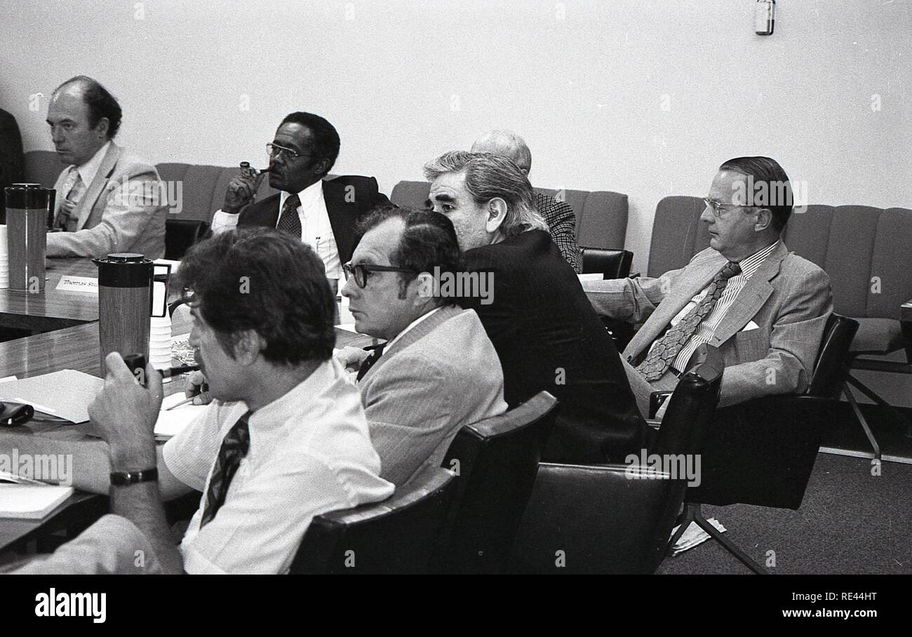 MEN SITTING GATHERED AROUND A TABLE, HAVING A MEETING. 4-12-78 LA ...
