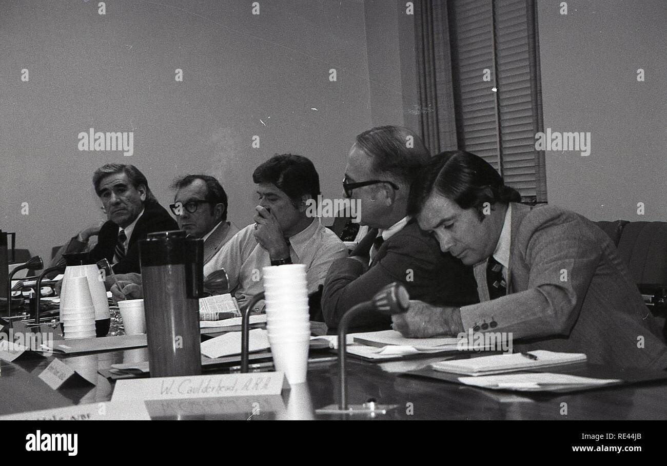 MEN SITTING GATHERED AROUND A TABLE, HAVING A MEETING. 4-12-78 LA ...