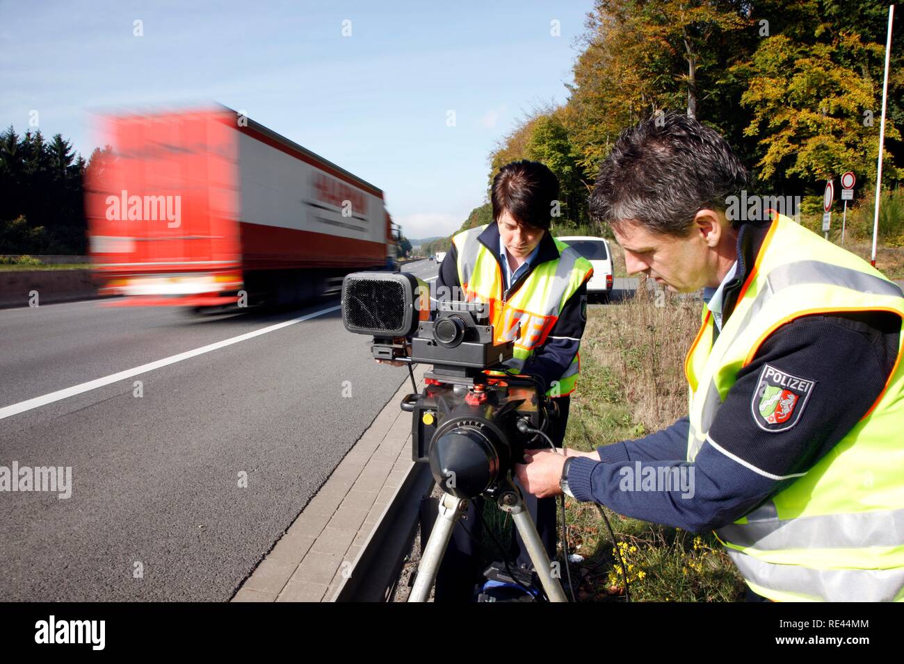 Police officers of the highway patrol errecting a radar measuring ...