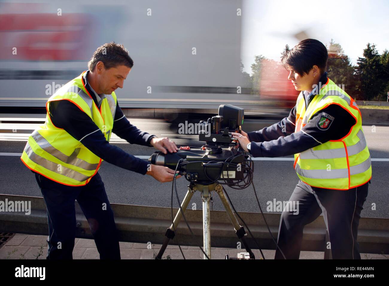 Police officers of the highway patrol errecting a radar measuring ...