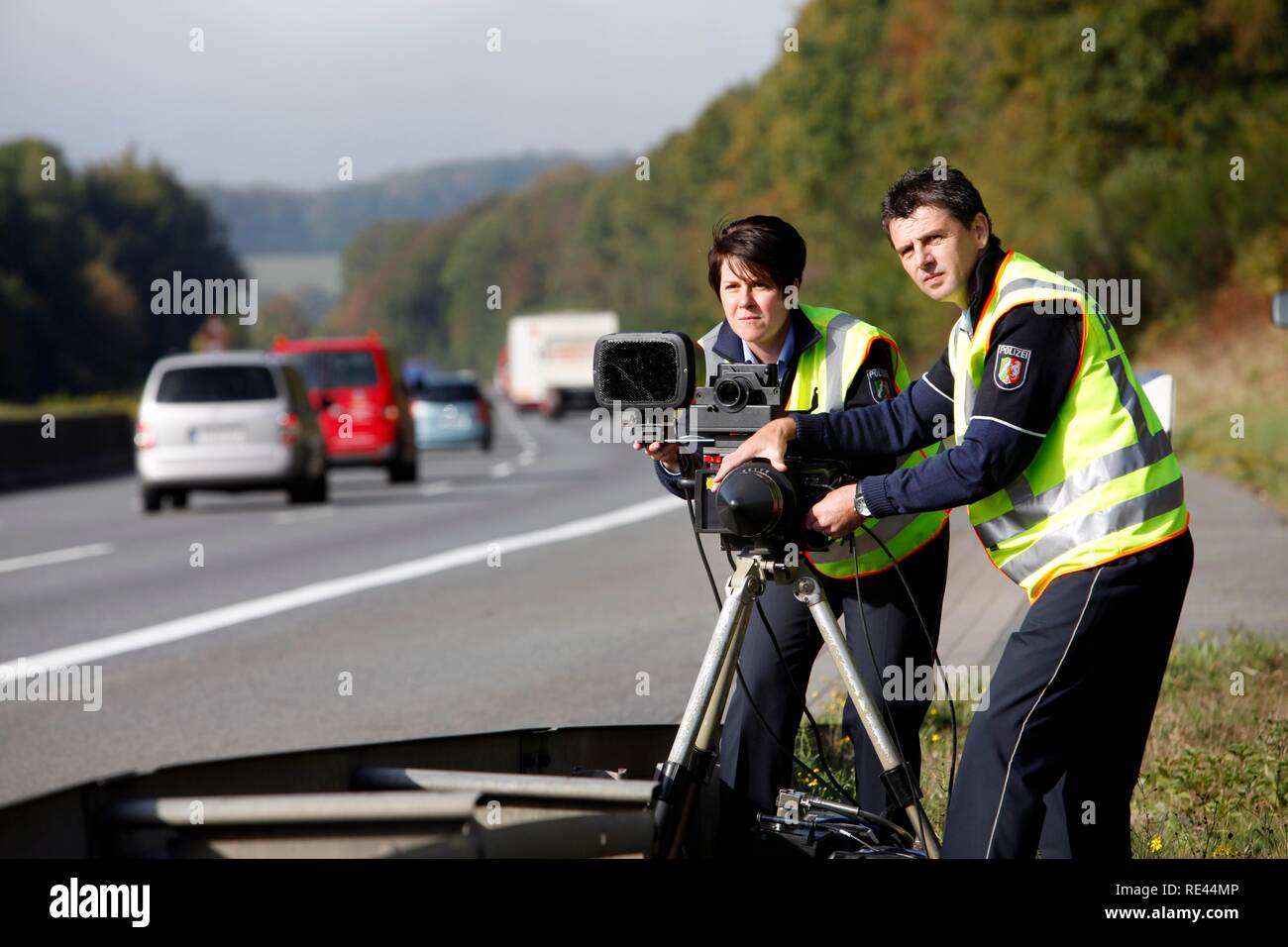 Police officers of the highway patrol errecting a radar measuring ...