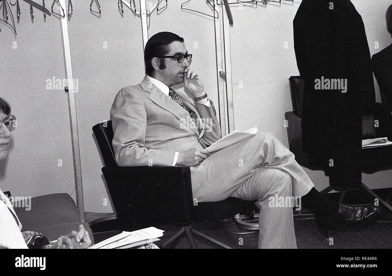 MEN SITTING GATHERED AROUND A TABLE, HAVING A MEETING. 4-12-78 LA ...
