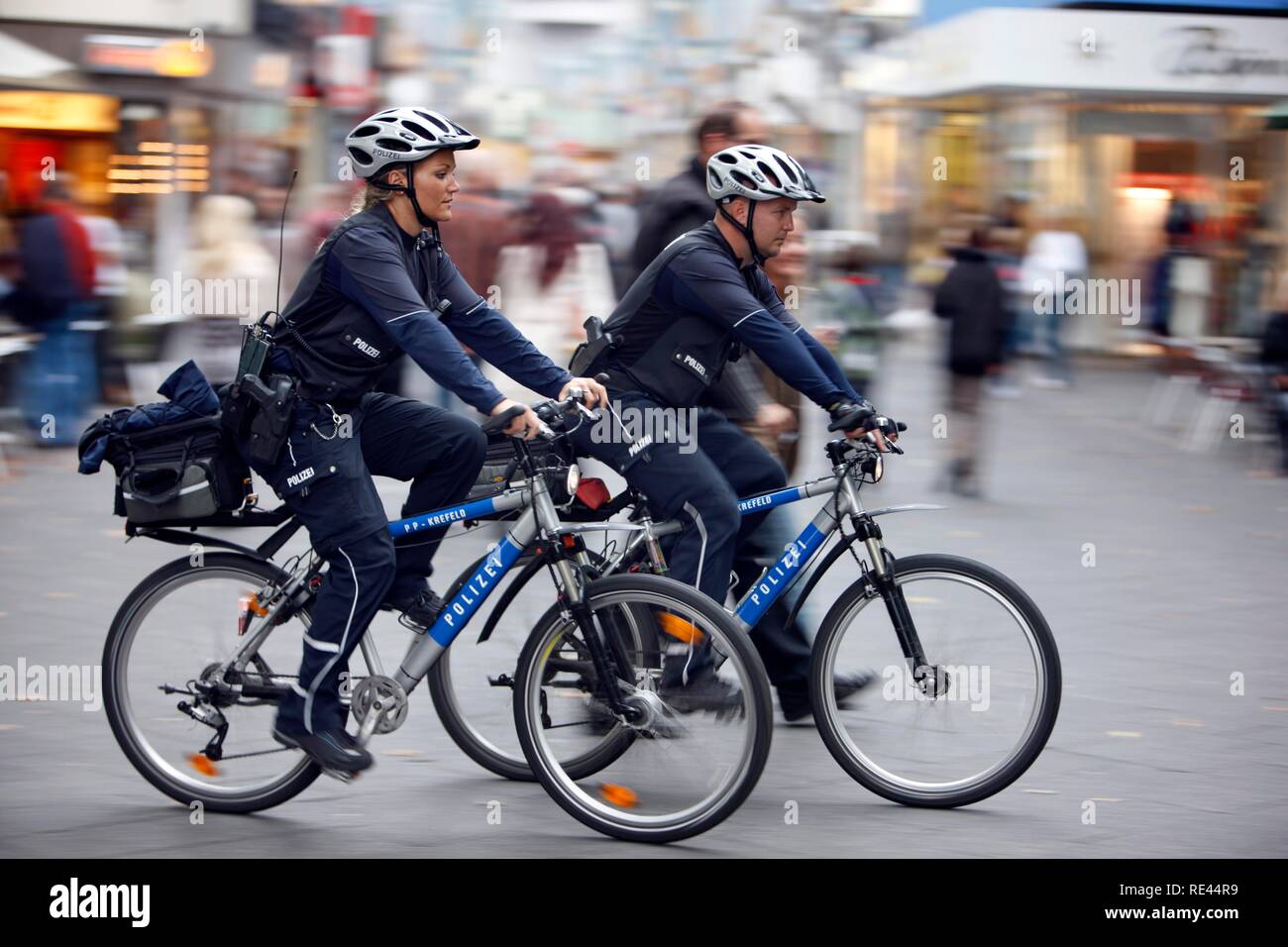 Bike police patrolling in a pedestrian zone Stock Photo - Alamy
