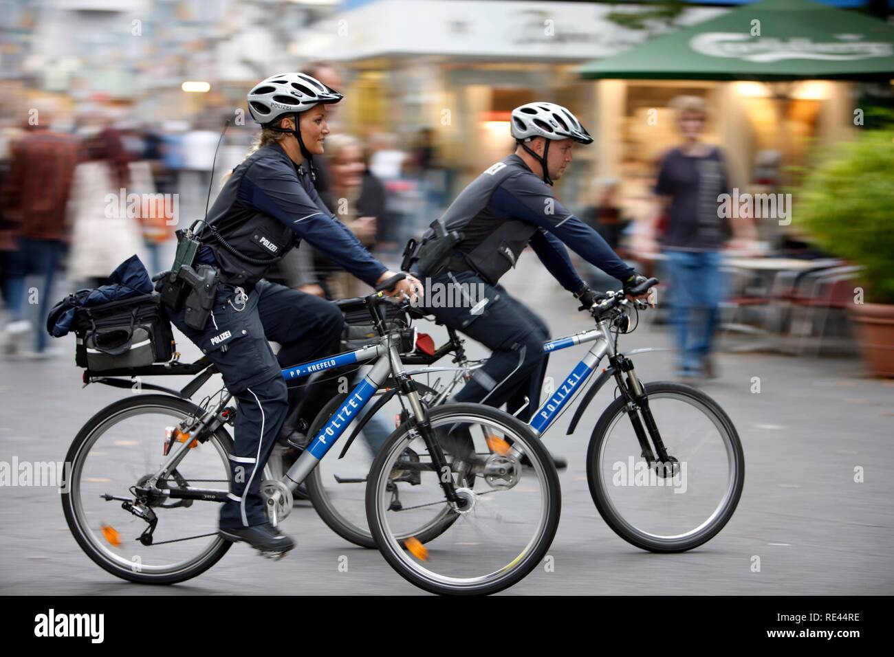 Bike police patrolling in a pedestrian zone Stock Photo - Alamy